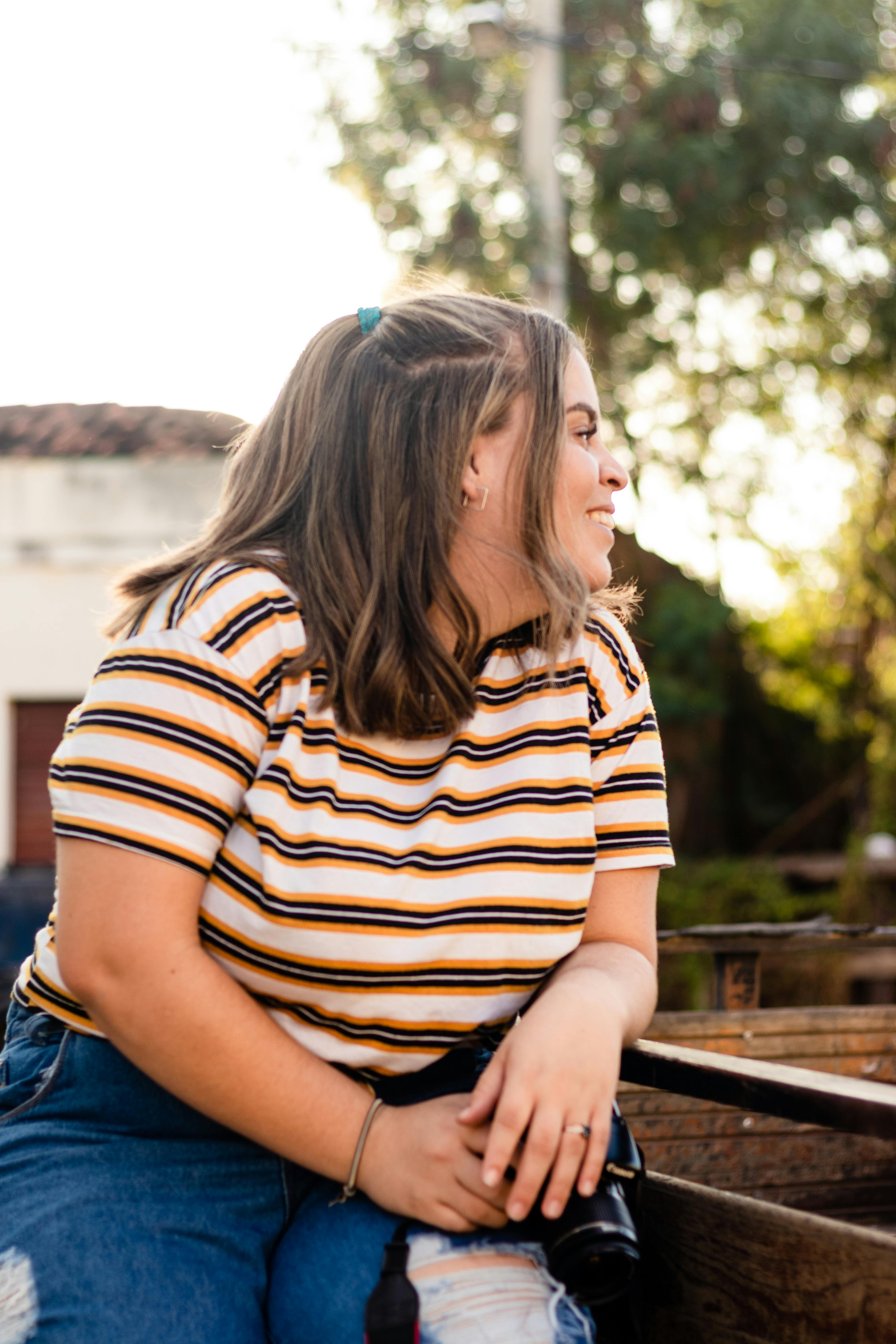 Smiling Woman in Varsity Jacket · Free Stock Photo