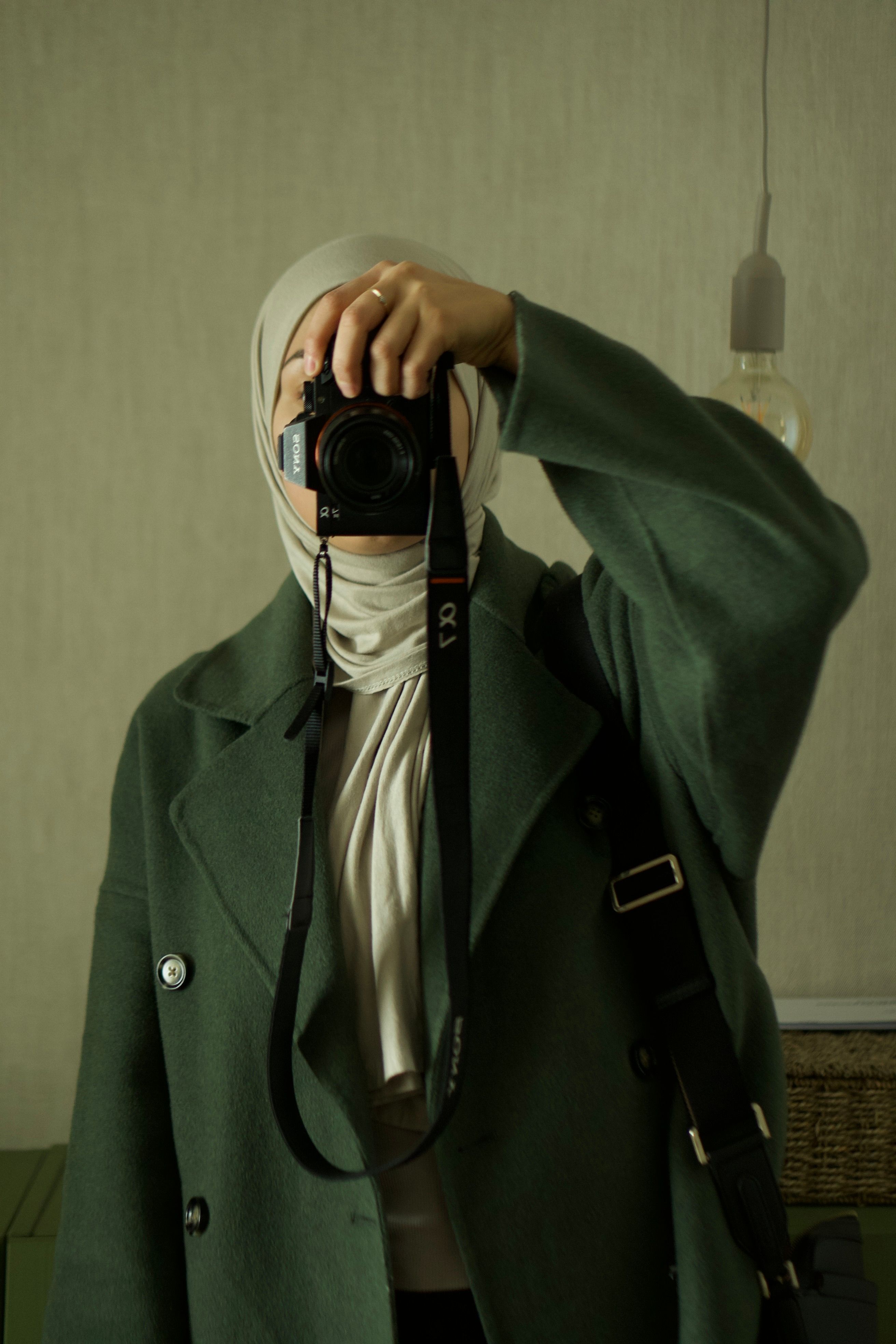 Woman in Coat Taking Pictures with Camera · Free Stock Photo