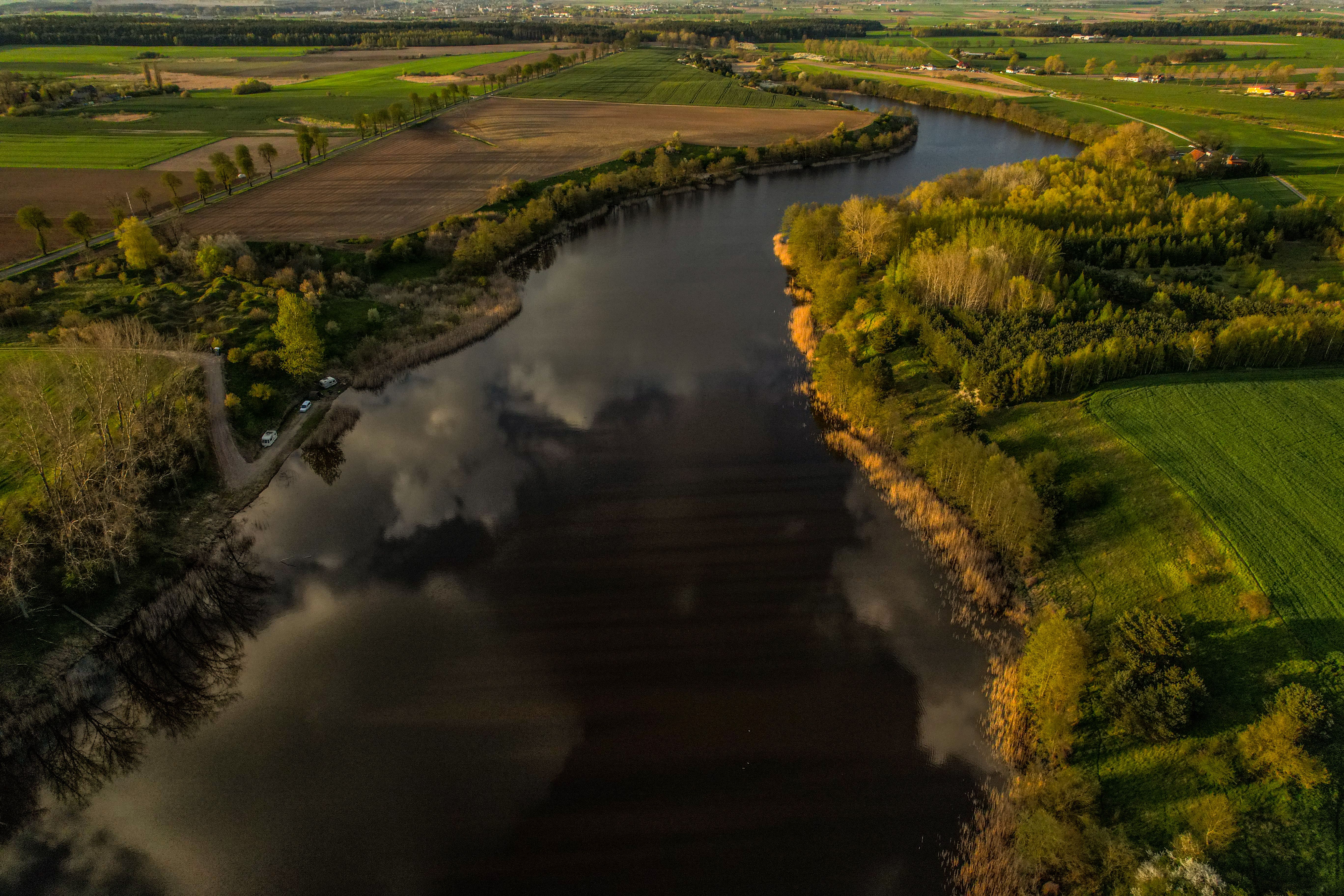 Lake between Rural Fields · Free Stock Photo