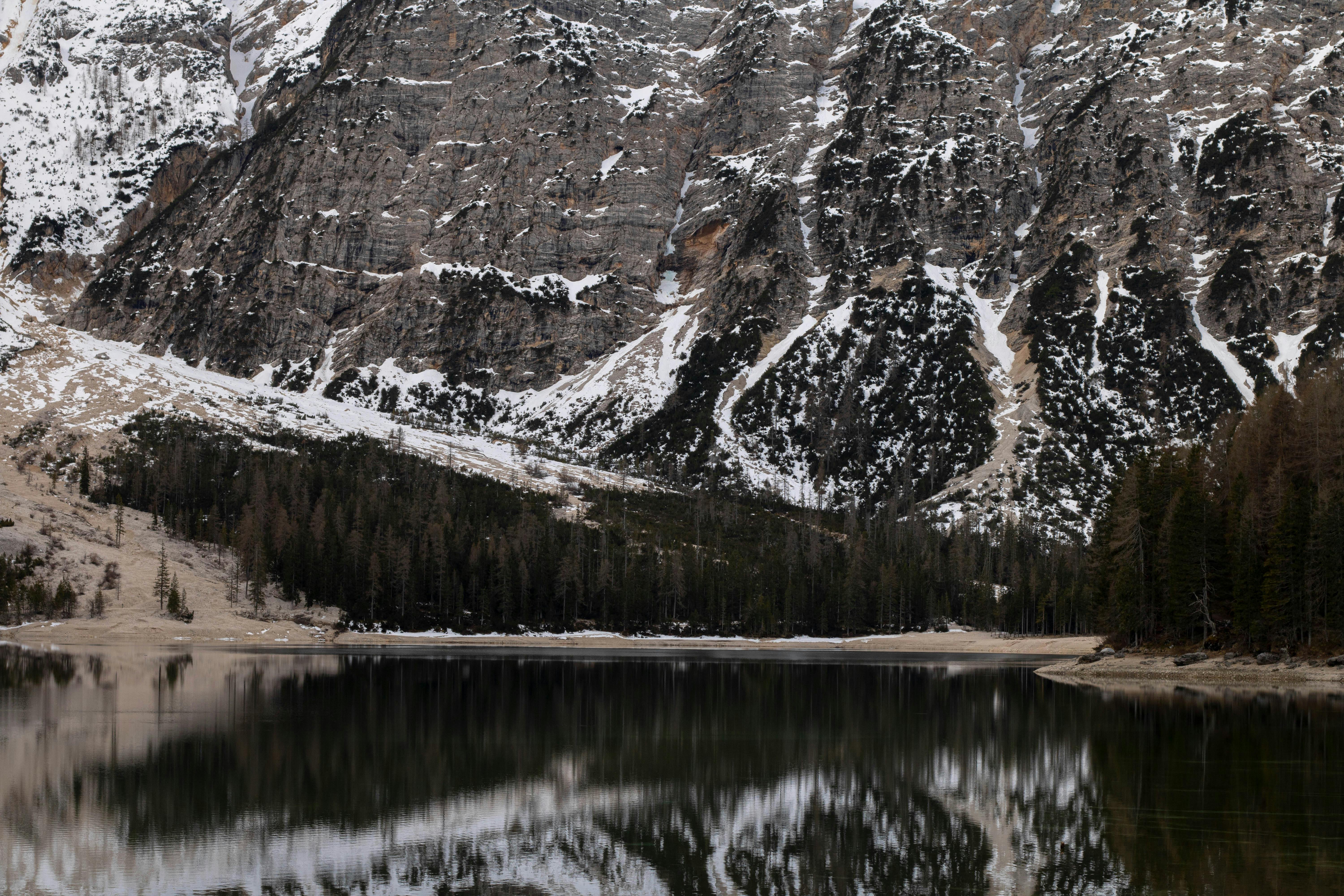 Lake under Steep Rocky Mountain · Free Stock Photo