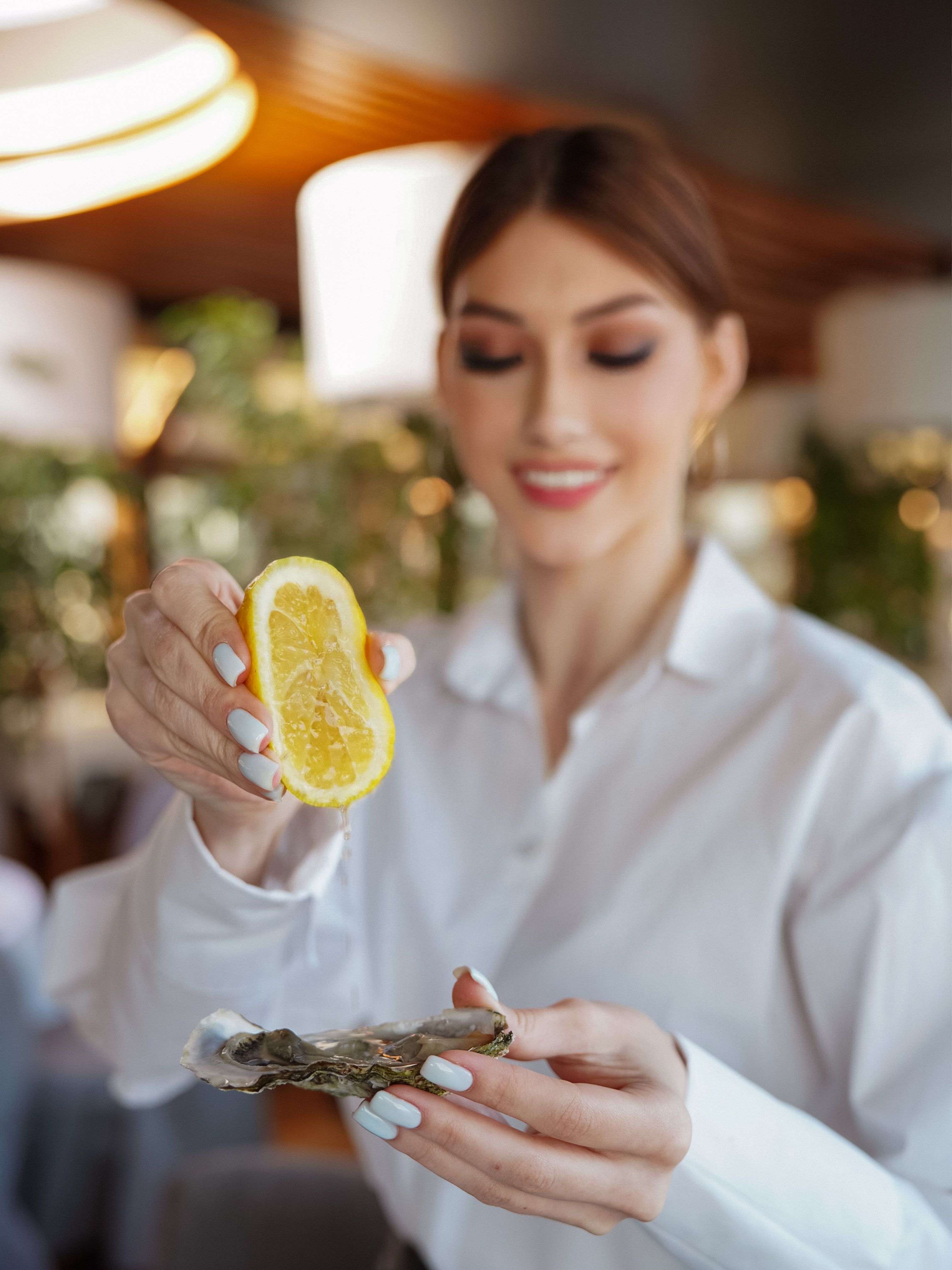 Woman Eating an Oyster · Free Stock Photo