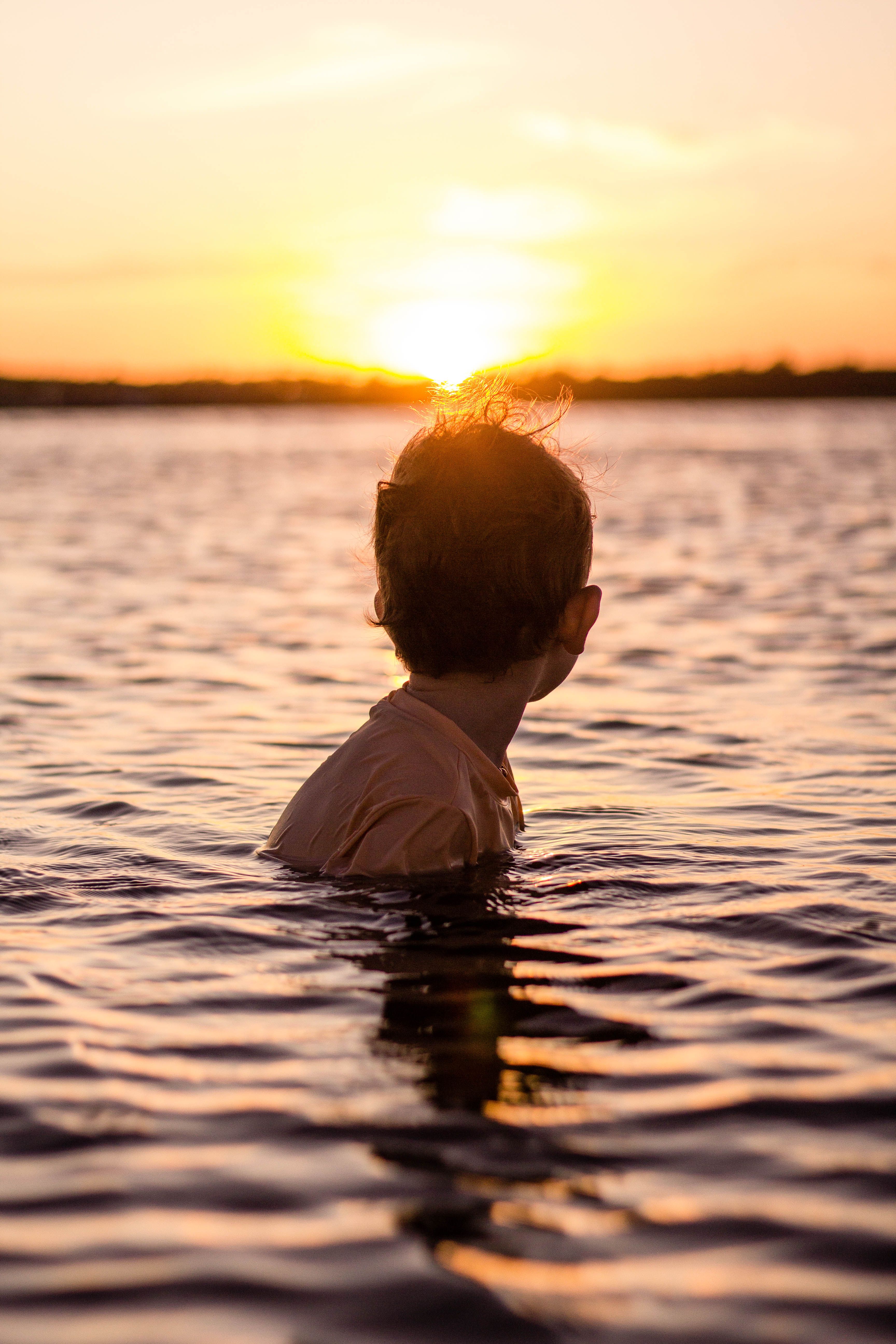 Portrait of a Boy Wearing a Sun Hat Holding a Hoe · Free Stock Photo