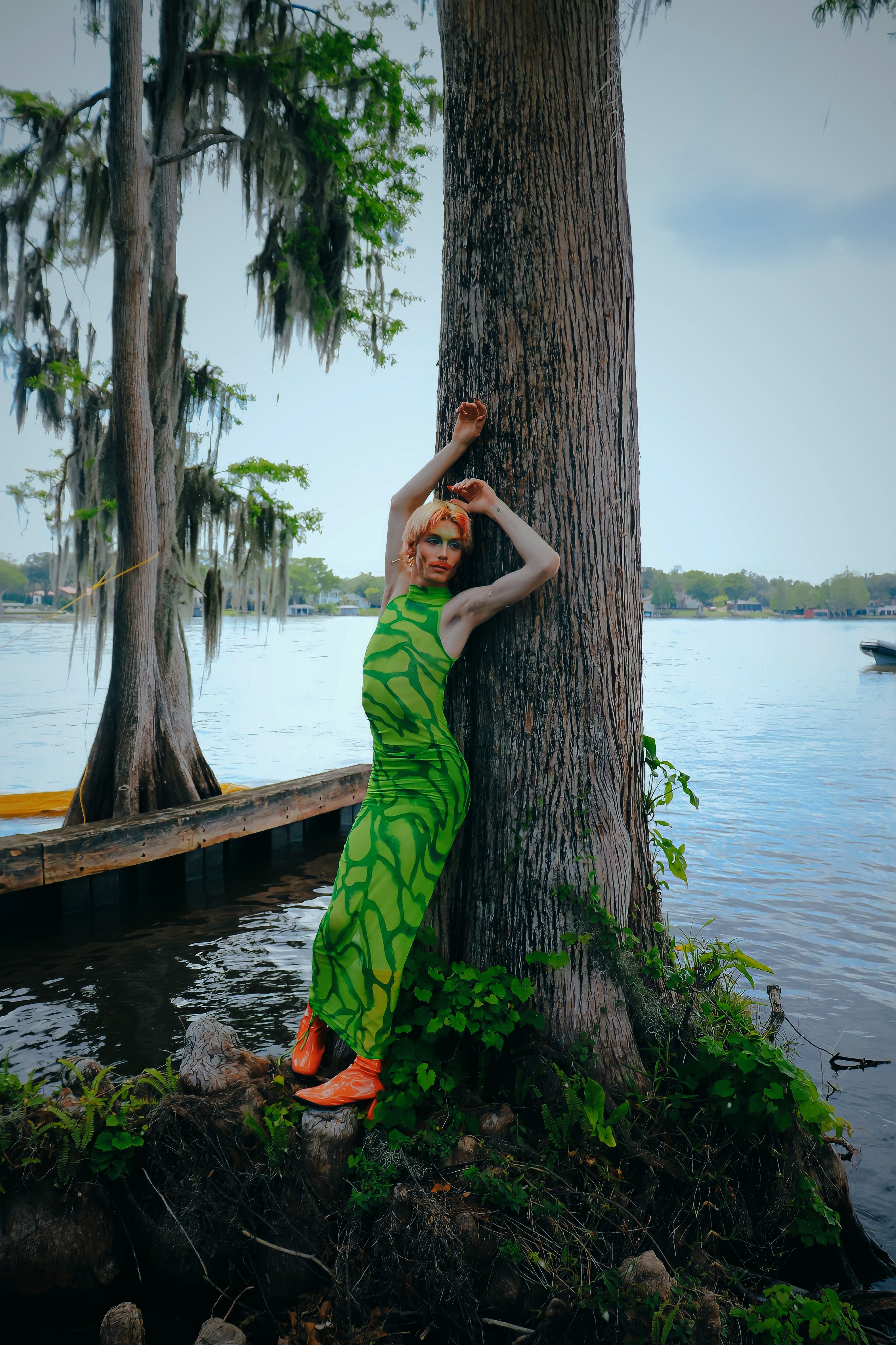 Person Leaning on Tree by Lake · Free Stock Photo