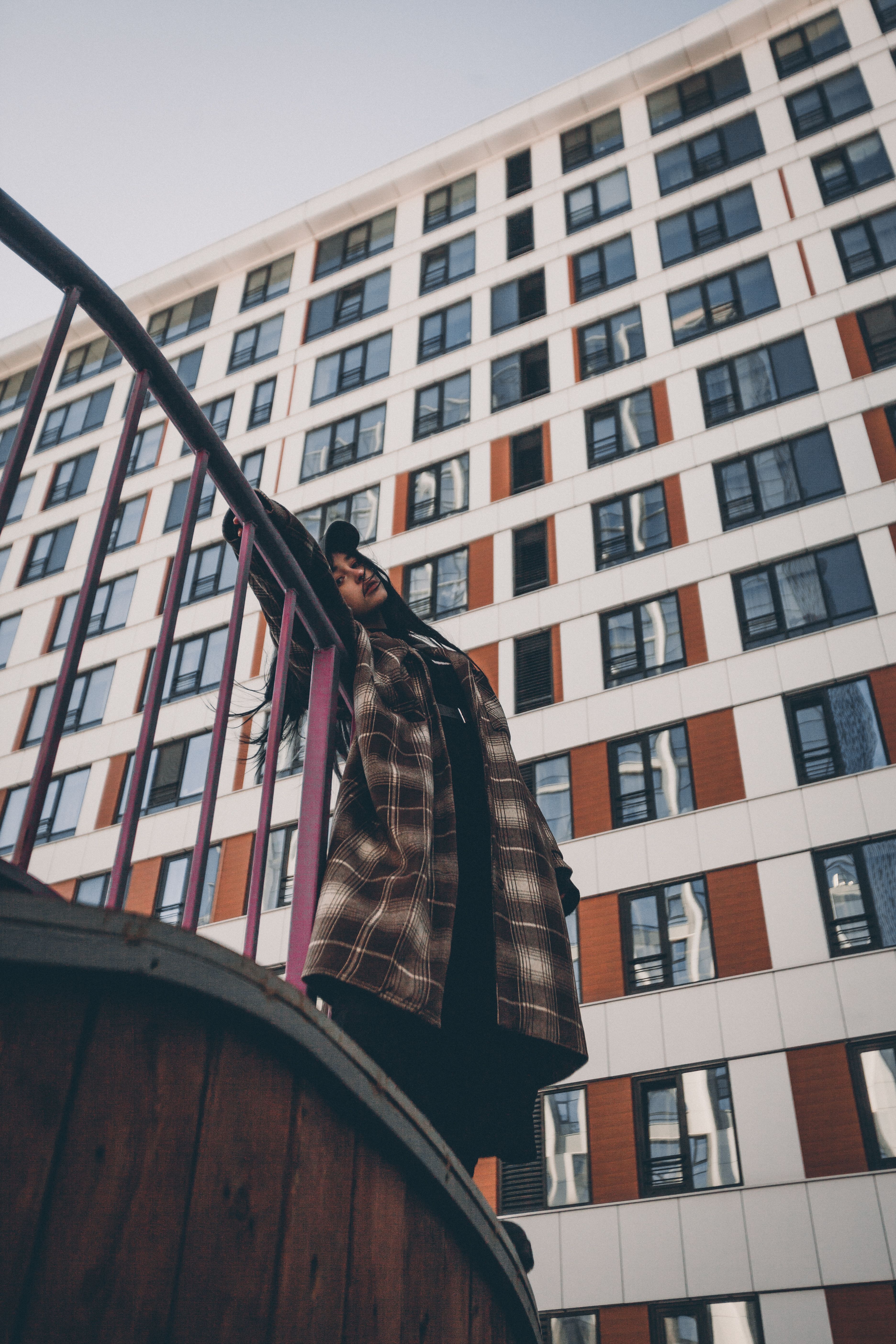 A Young Woman Posing in front of a Building · Free Stock Photo