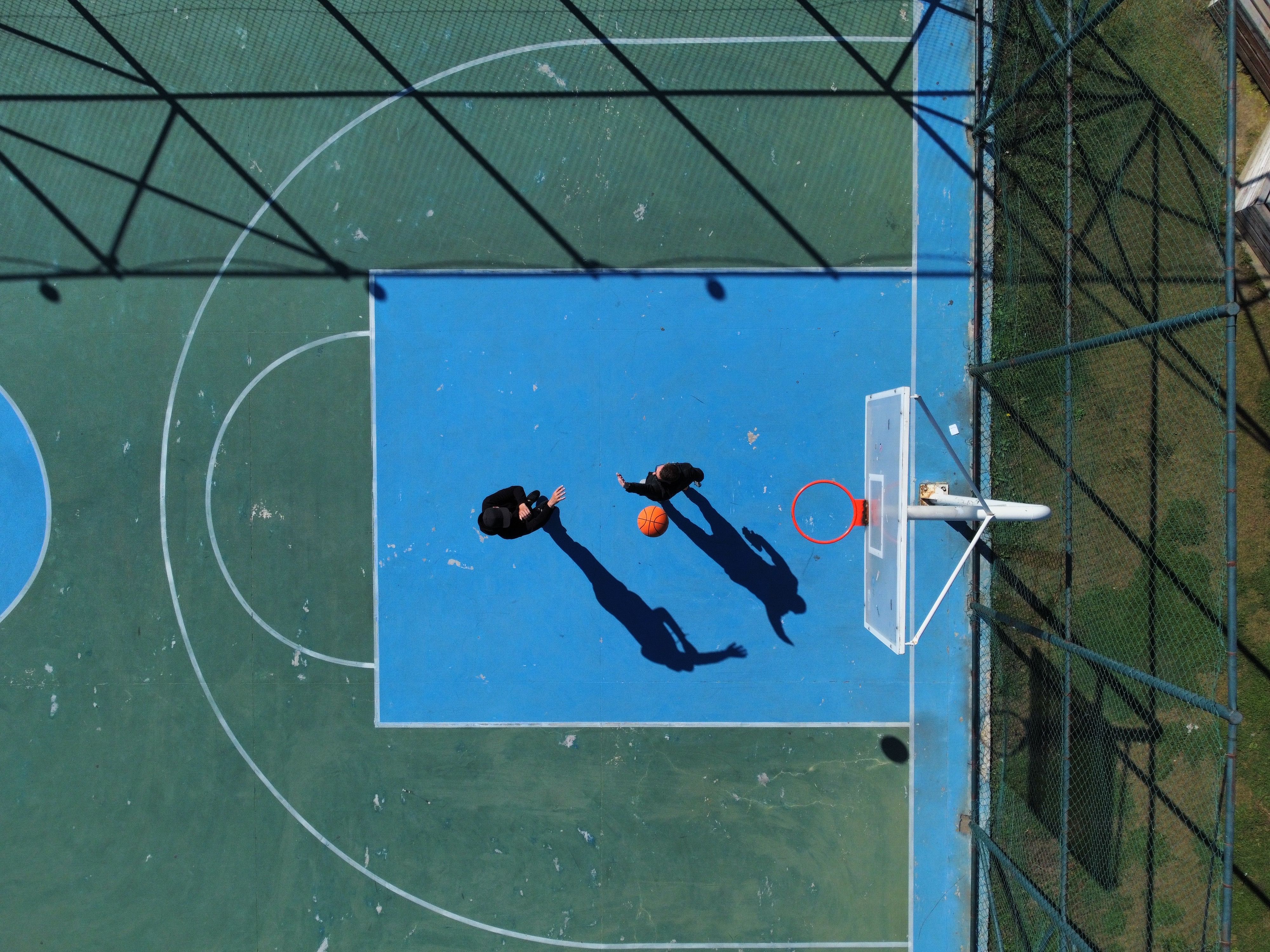 Woman Lying on Basketball Free Throw Line · Free Stock Photo