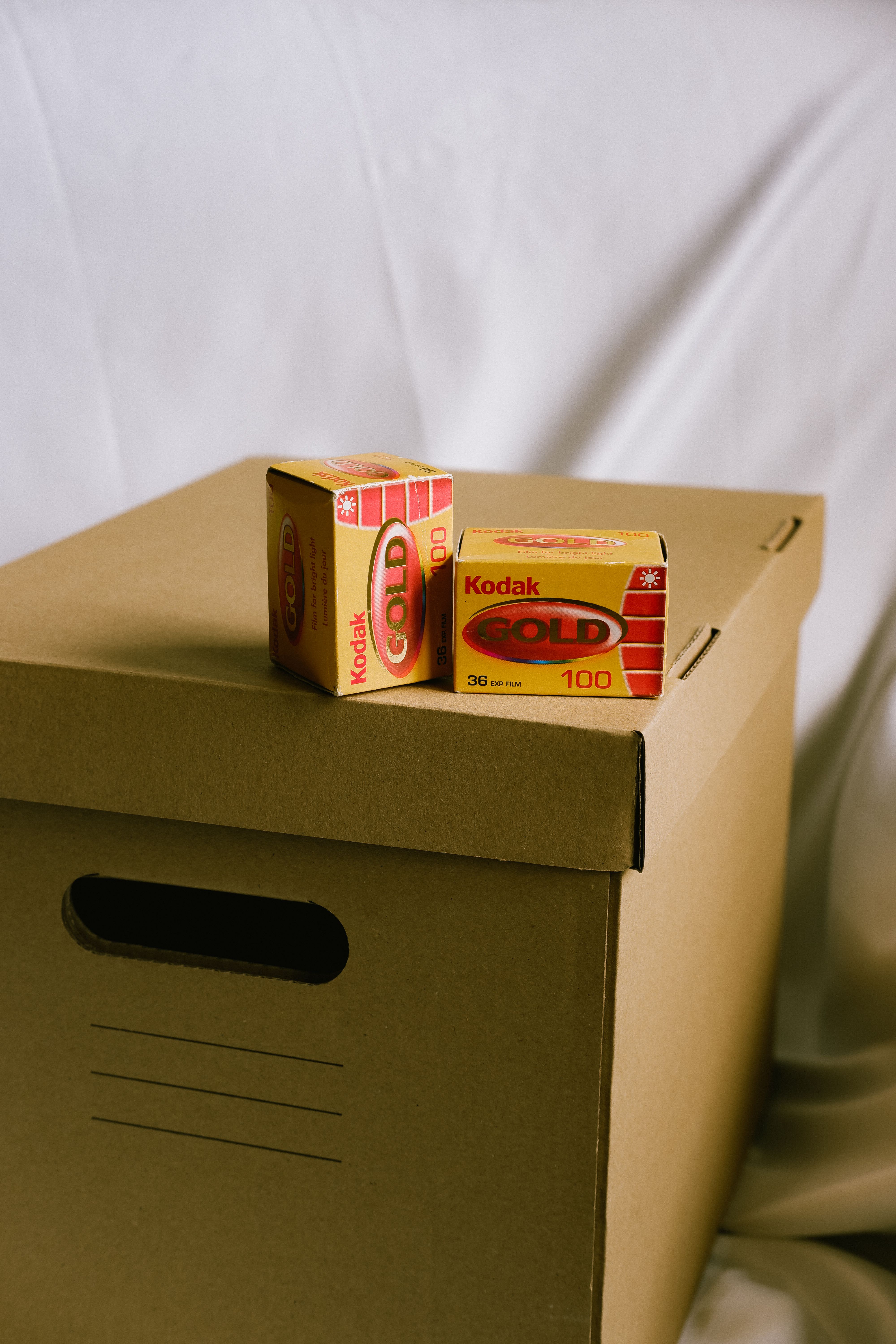 Film Cameras and Film Rolls in a Box · Free Stock Photo