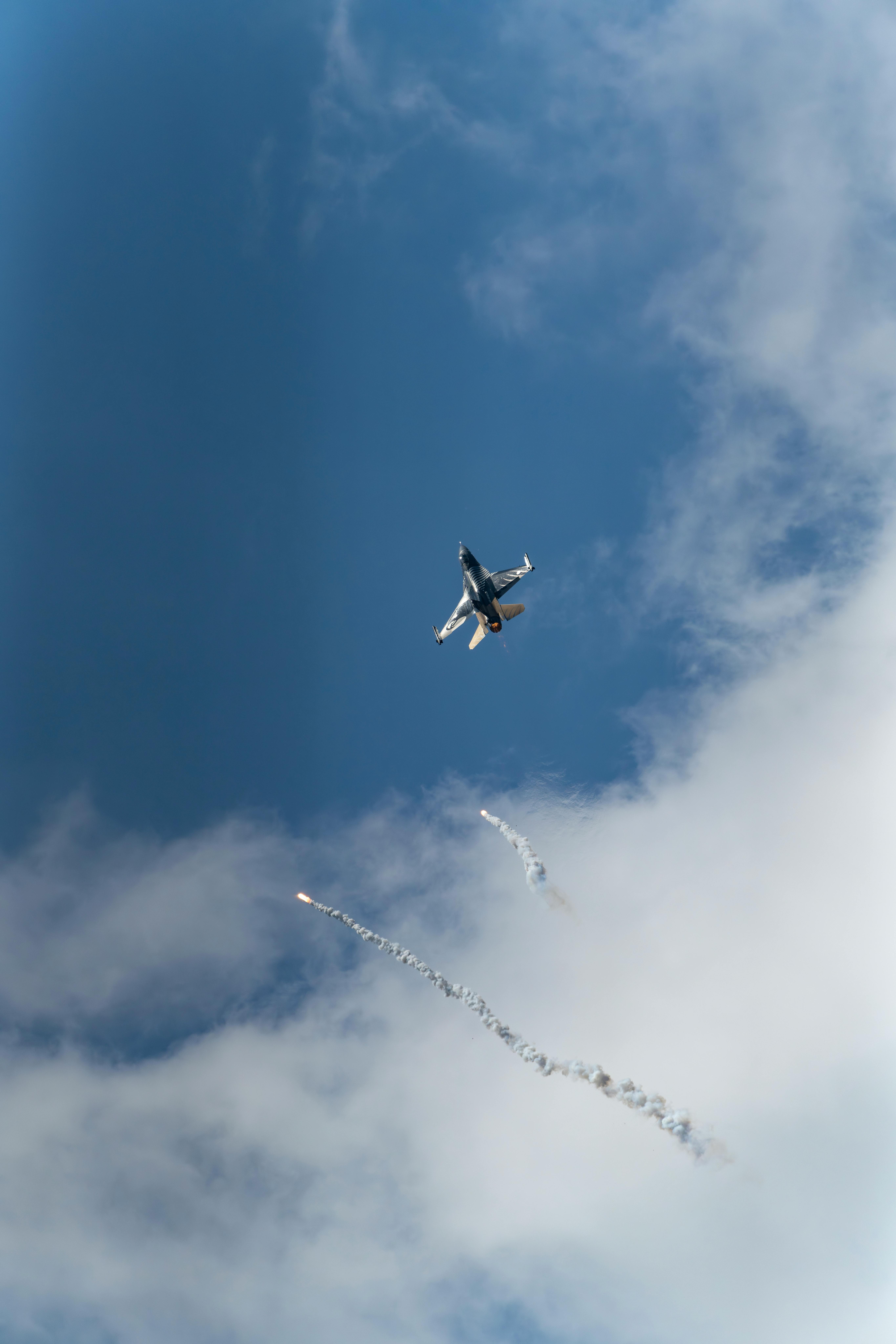 Grey Jet Plane Flying on Top of White Mountain · Free Stock Photo
