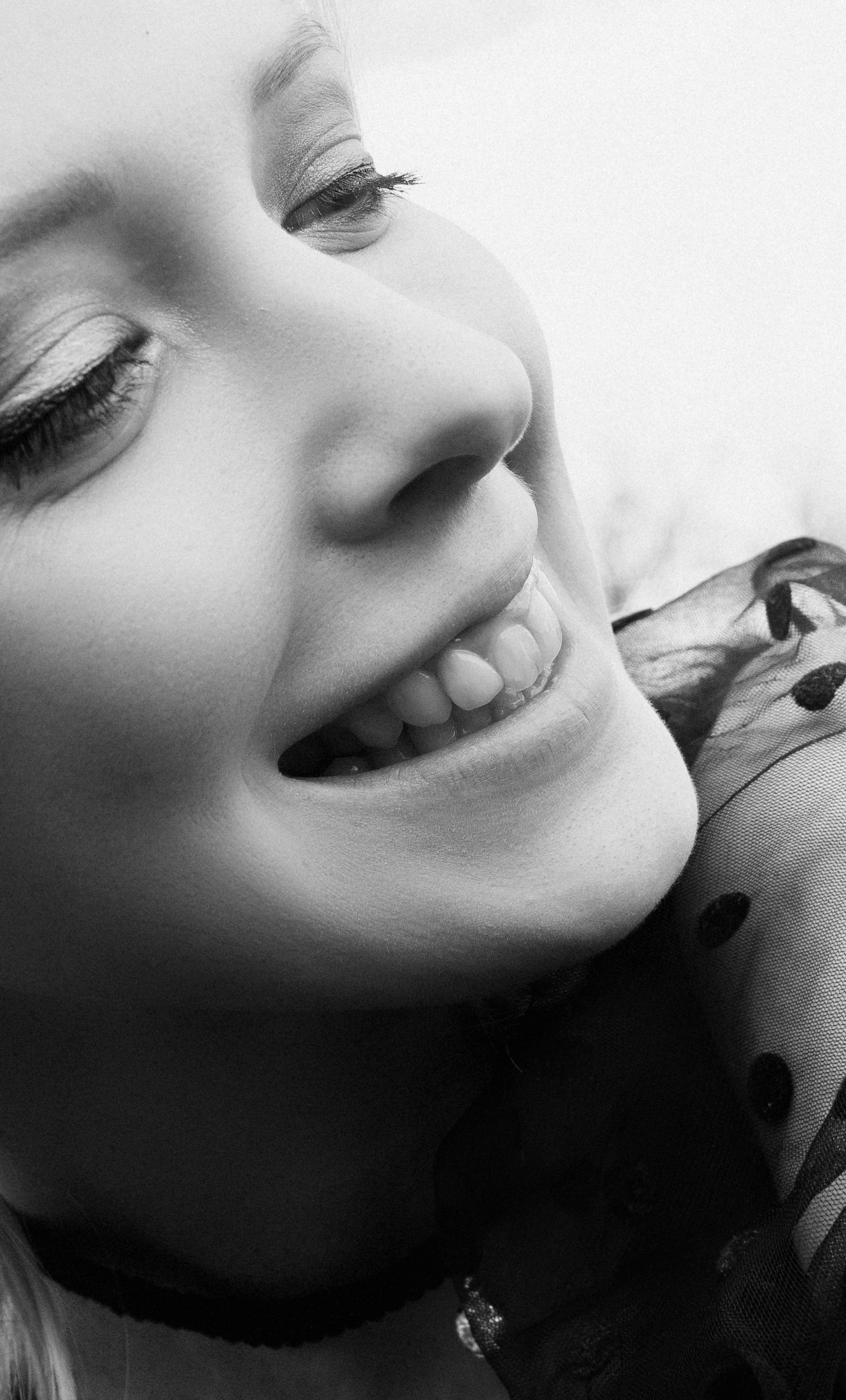 Woman Lying on Pouf, Touching Her Face and Smiling · Free Stock Photo