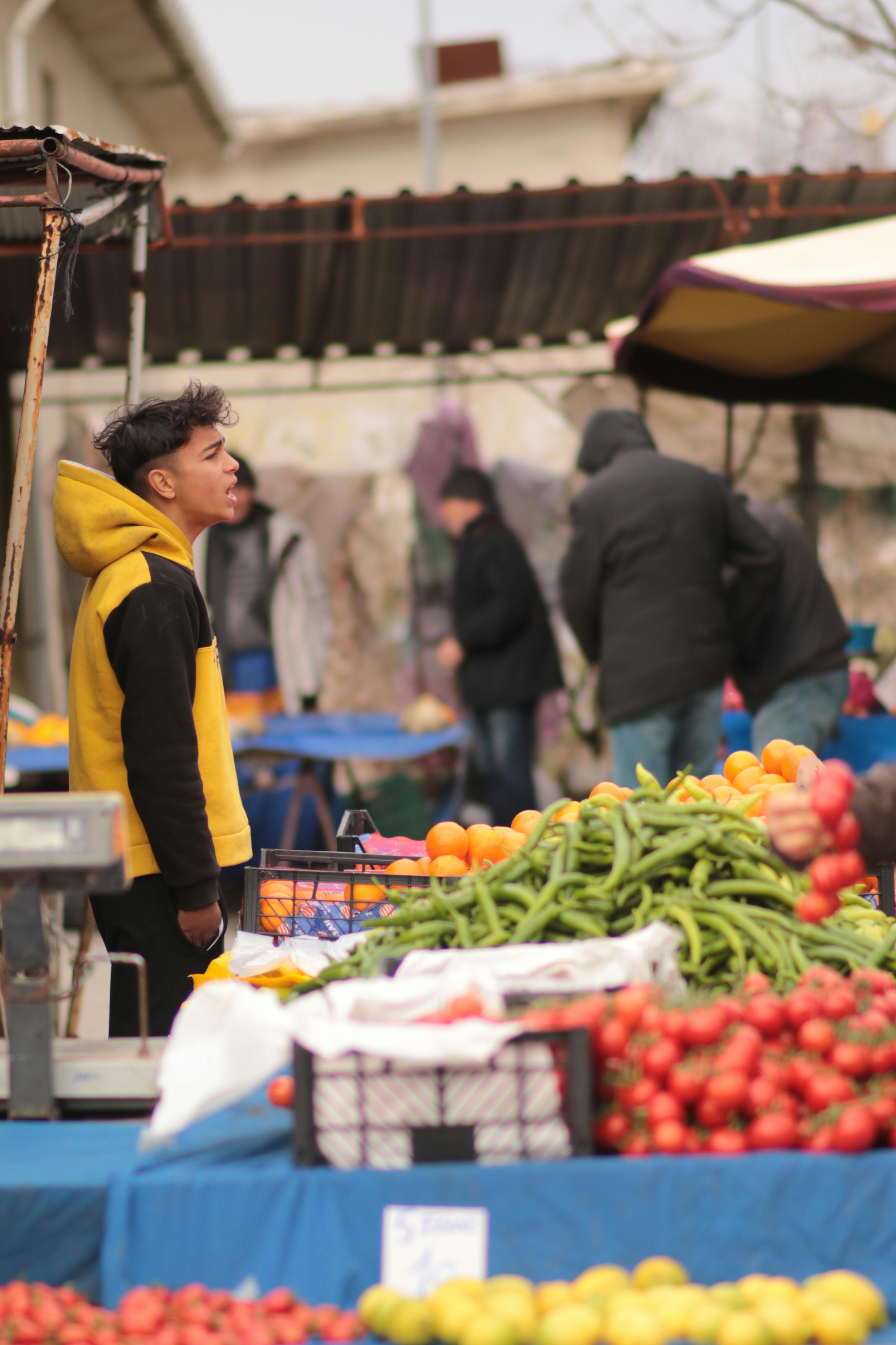 Merchant at Stall with Fresh Produce · Free Stock Photo