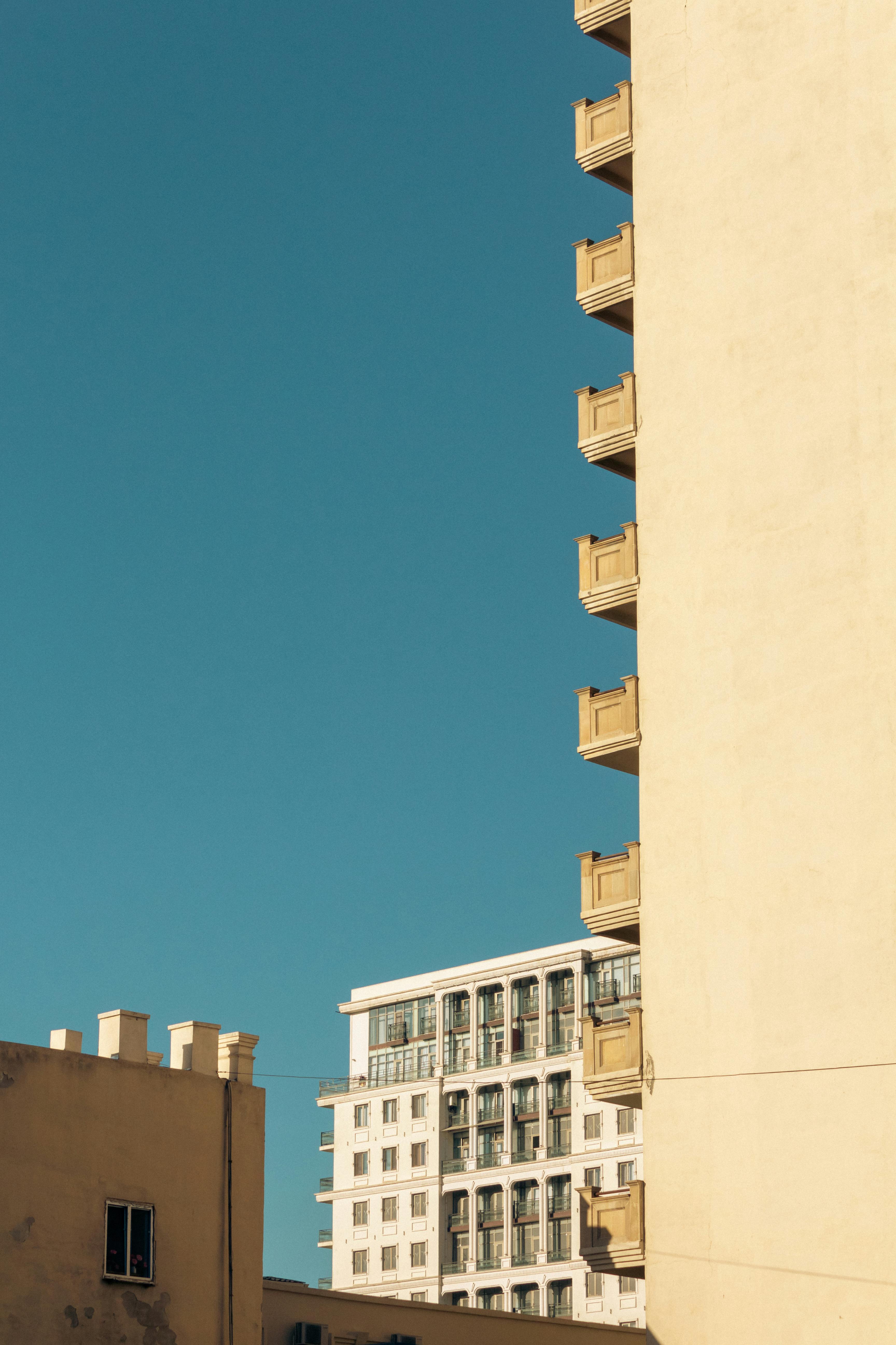 Facades of Colorful Tenement Houses Covered with Ivy · Free Stock Photo