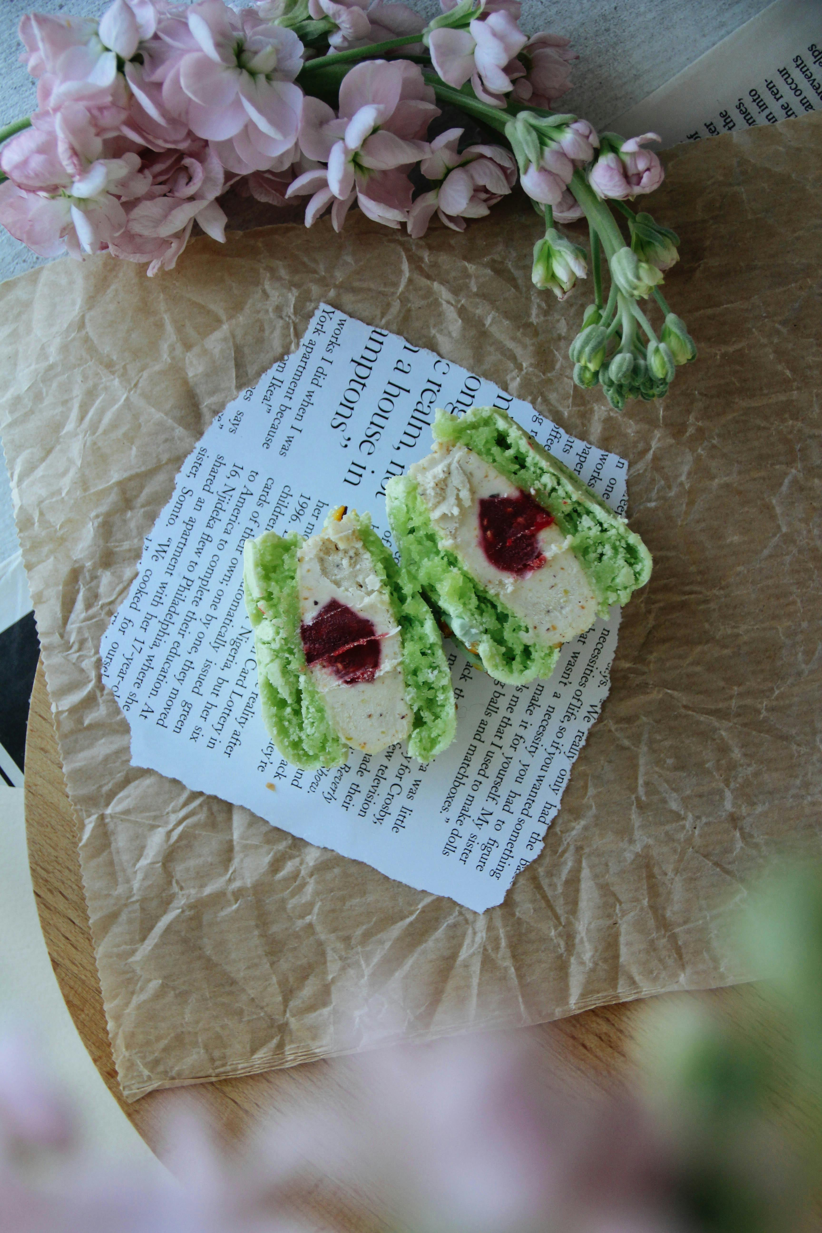 Green Macaron Cut in Half on a Piece of Book Page and Baking Paper ...