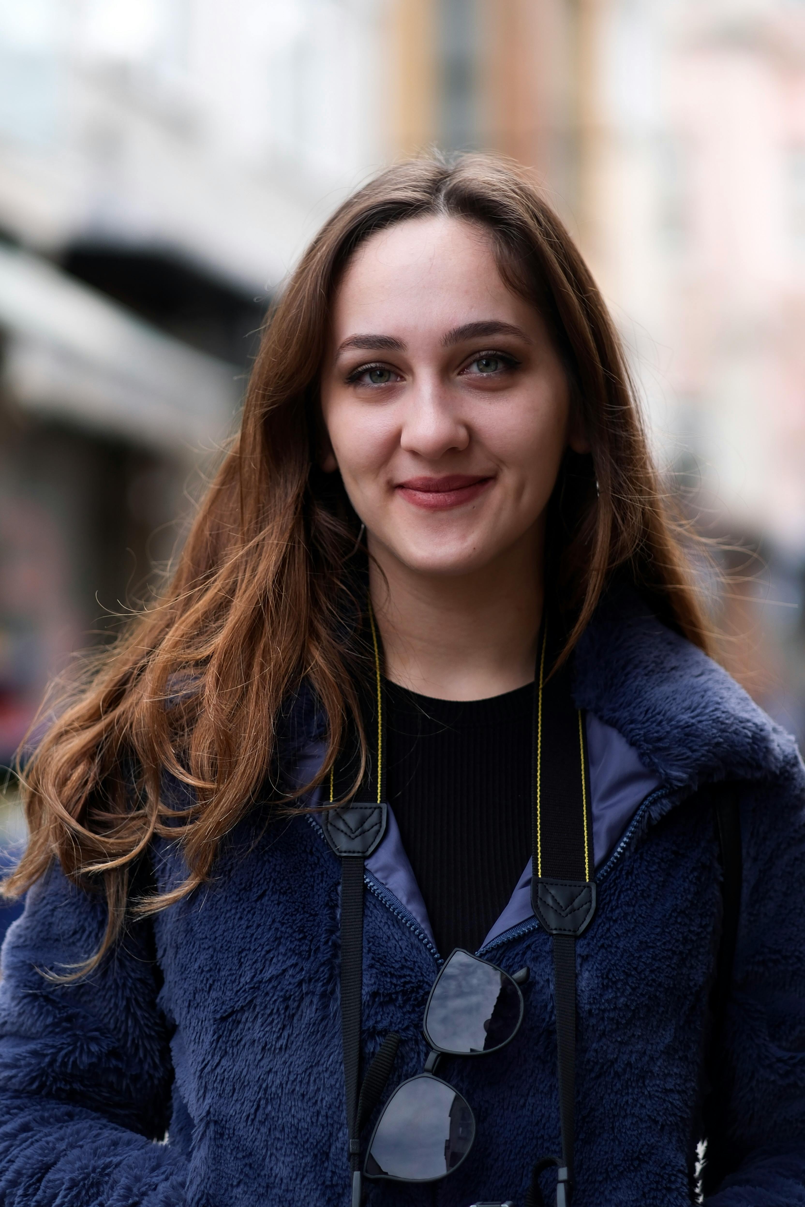 Portrait of Woman with Camera around her Neck · Free Stock Photo