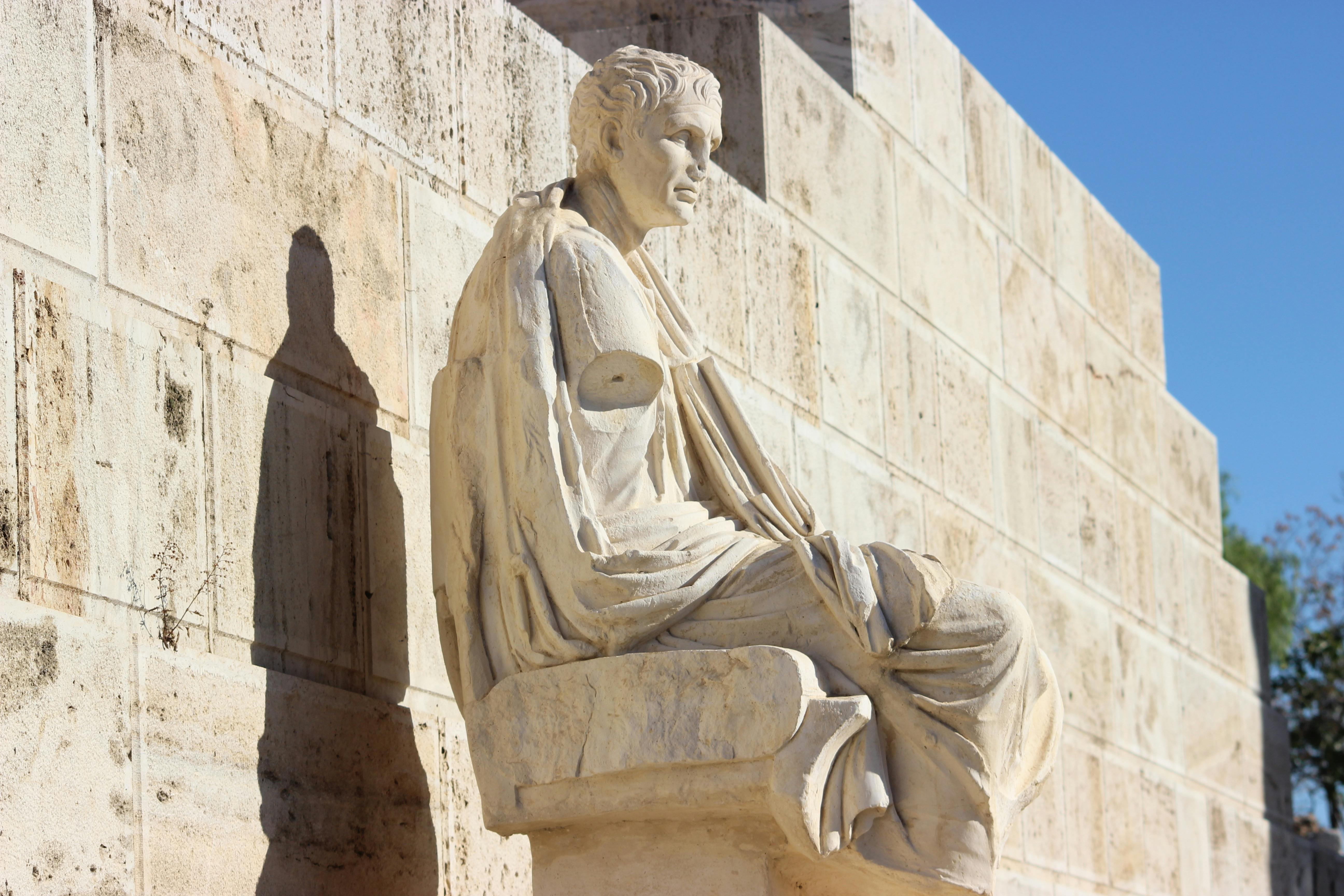 Ancient Statue of Sitting Man · Free Stock Photo