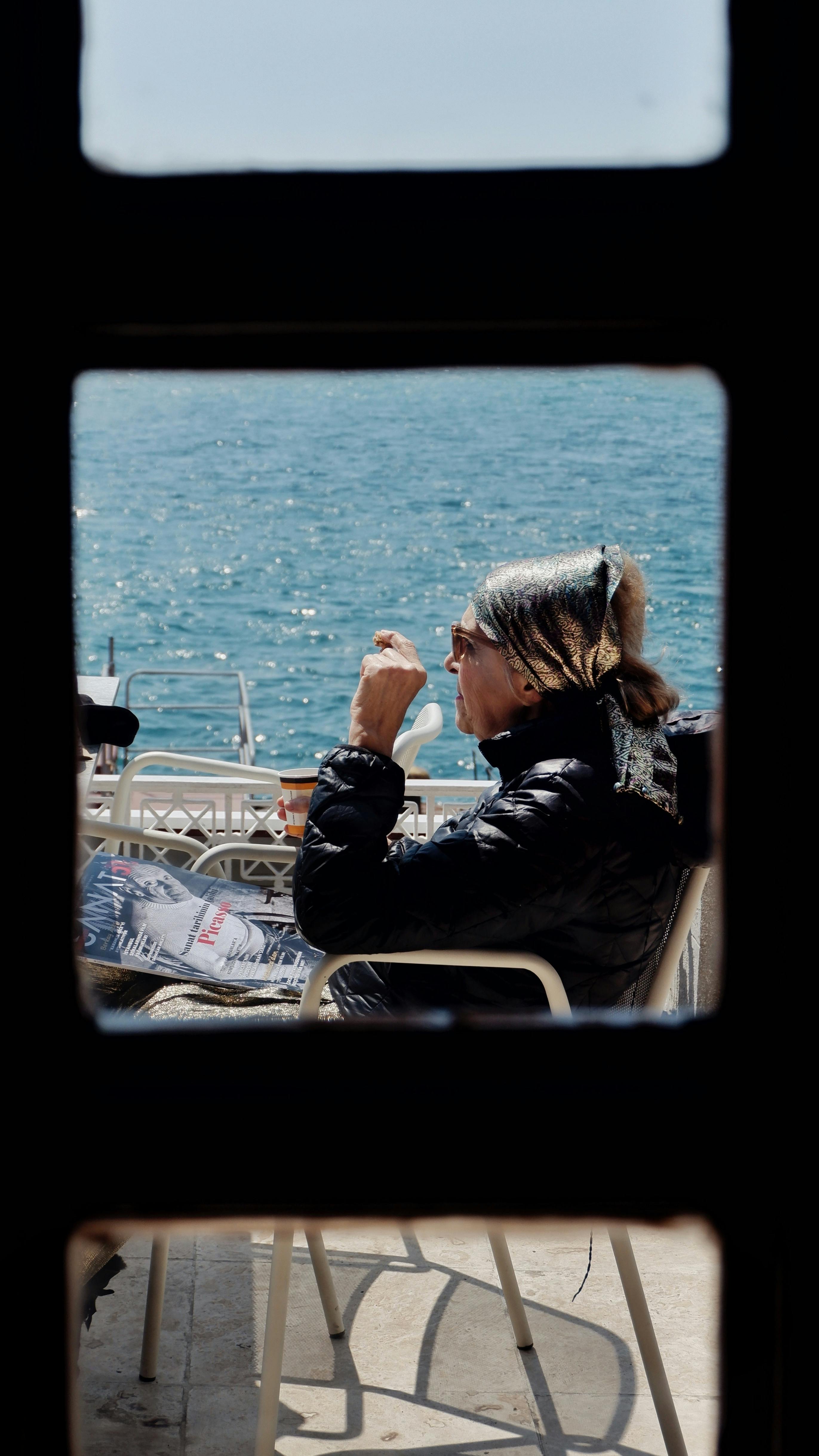 Brunette Woman in Bra and Jeans Sitting on Beach · Free Stock Photo