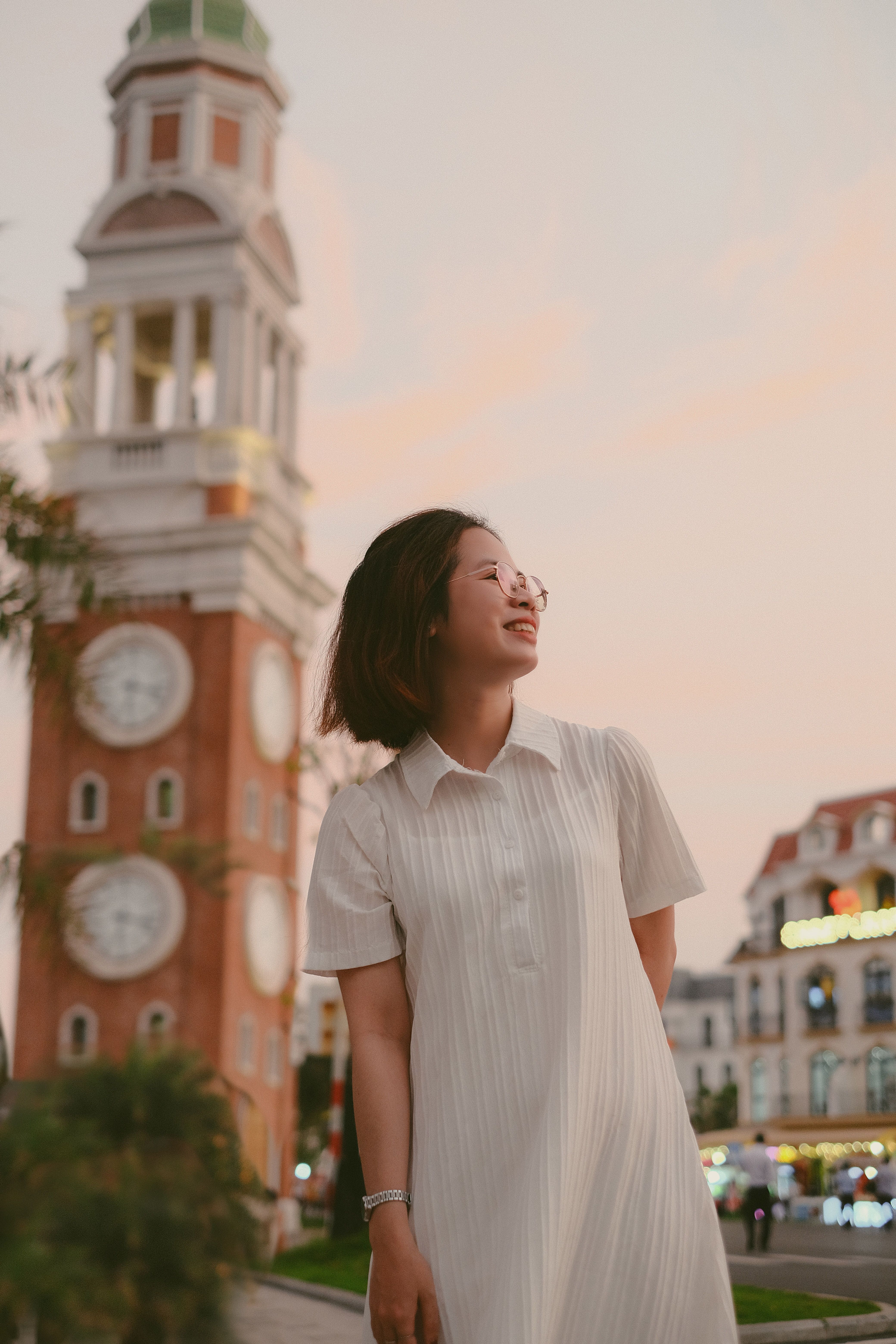Woman in White Dress Posing with Clock Tower behind · Free Stock Photo