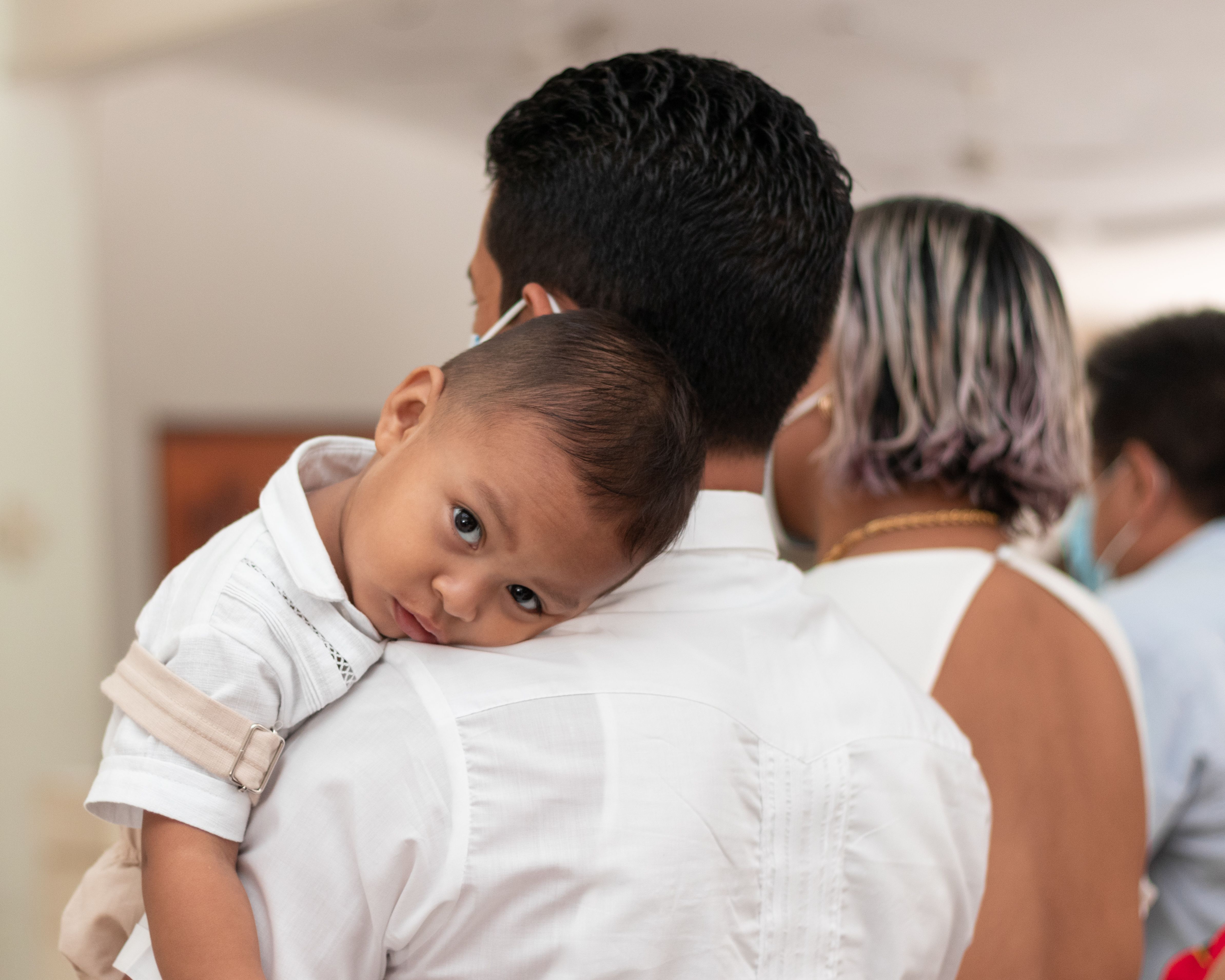Men in Traditional Uniforms Posing with a Baby Boy · Free Stock Photo