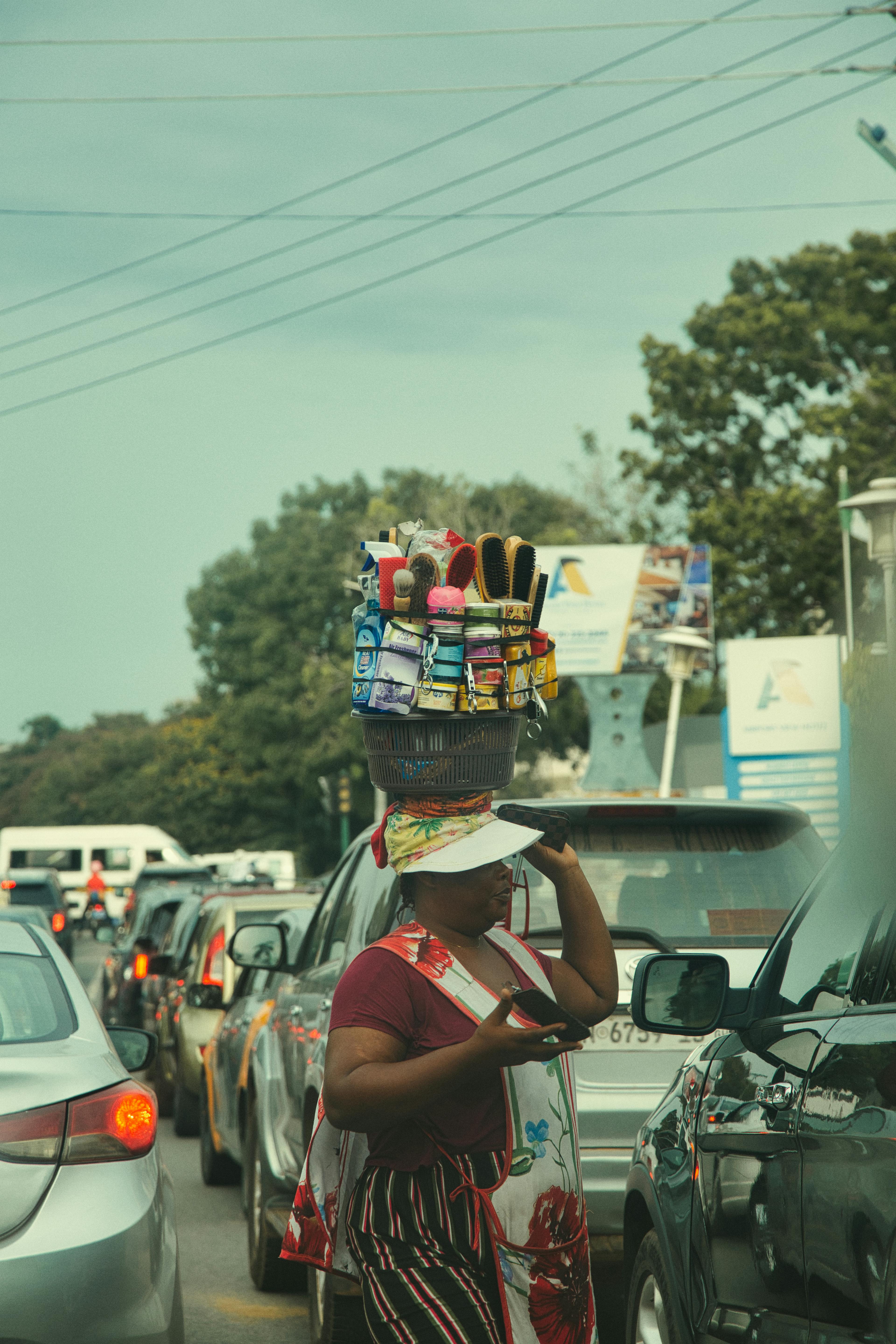 Woman Carrying Bucket on Head on Street · Free Stock Photo