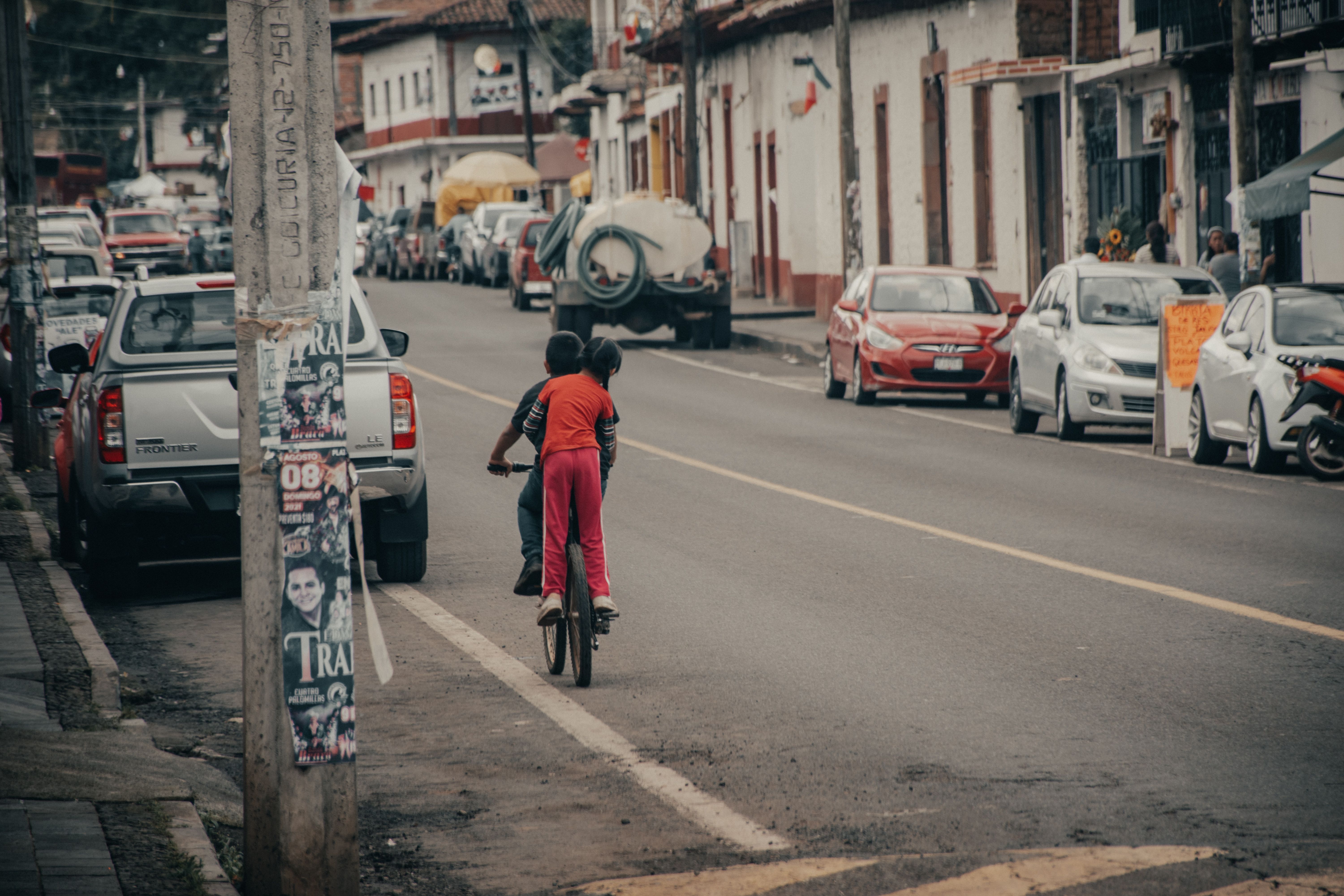 Boy Pushing Girl on Bicycle · Free Stock Photo
