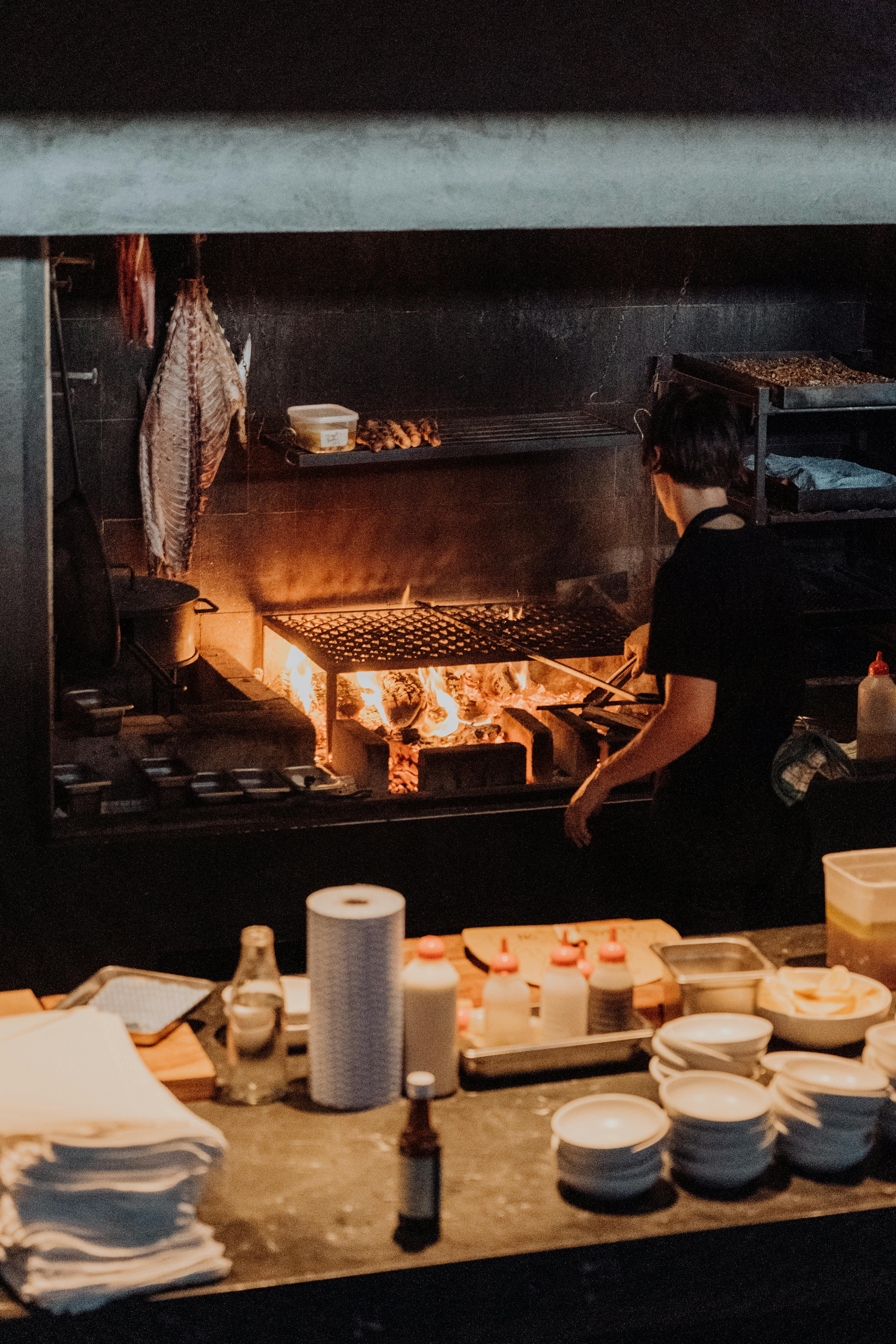 Cook at Heat BBQ in Restaurant · Free Stock Photo