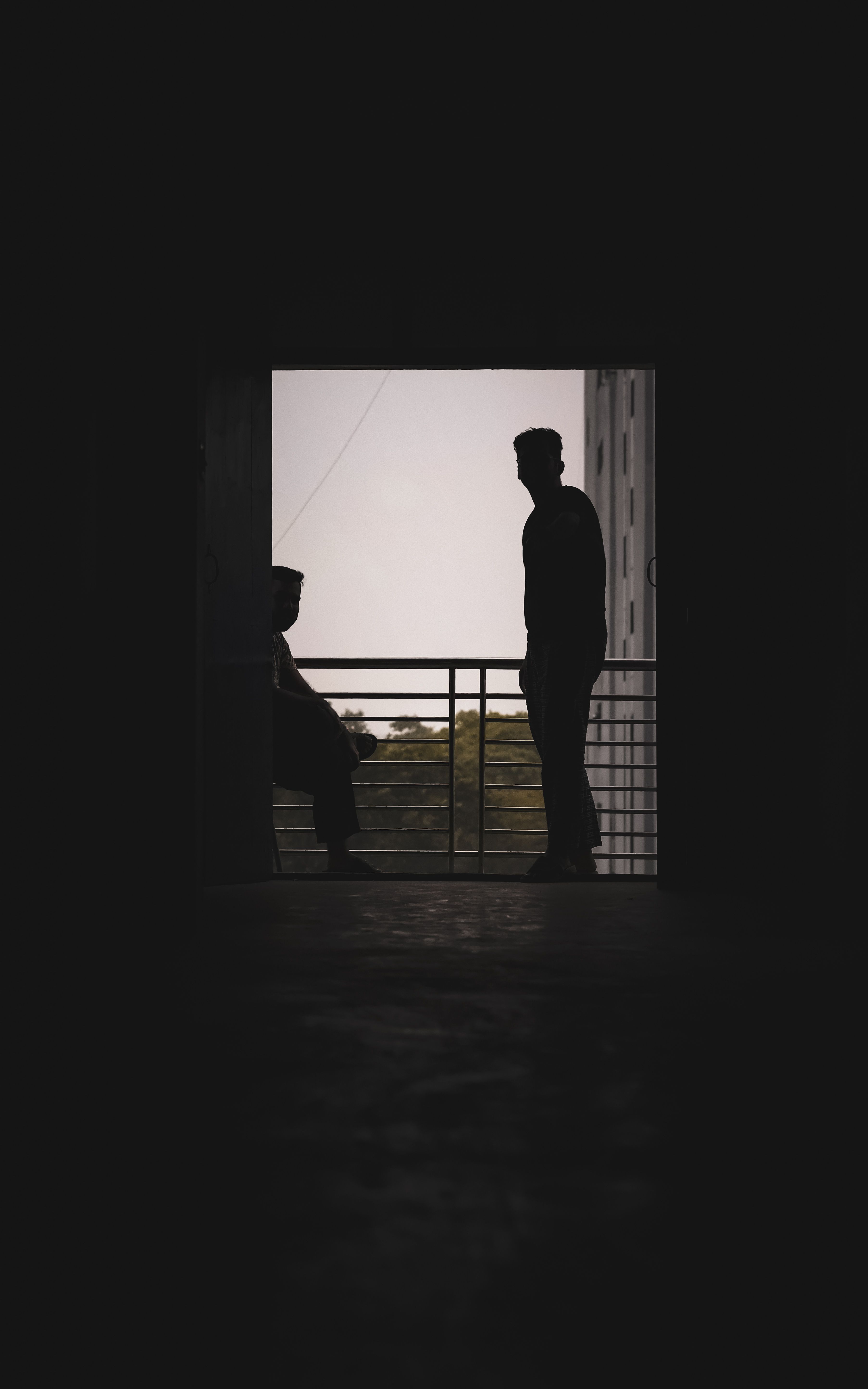 Mysterious person standing in the darkness · Free Stock Photo