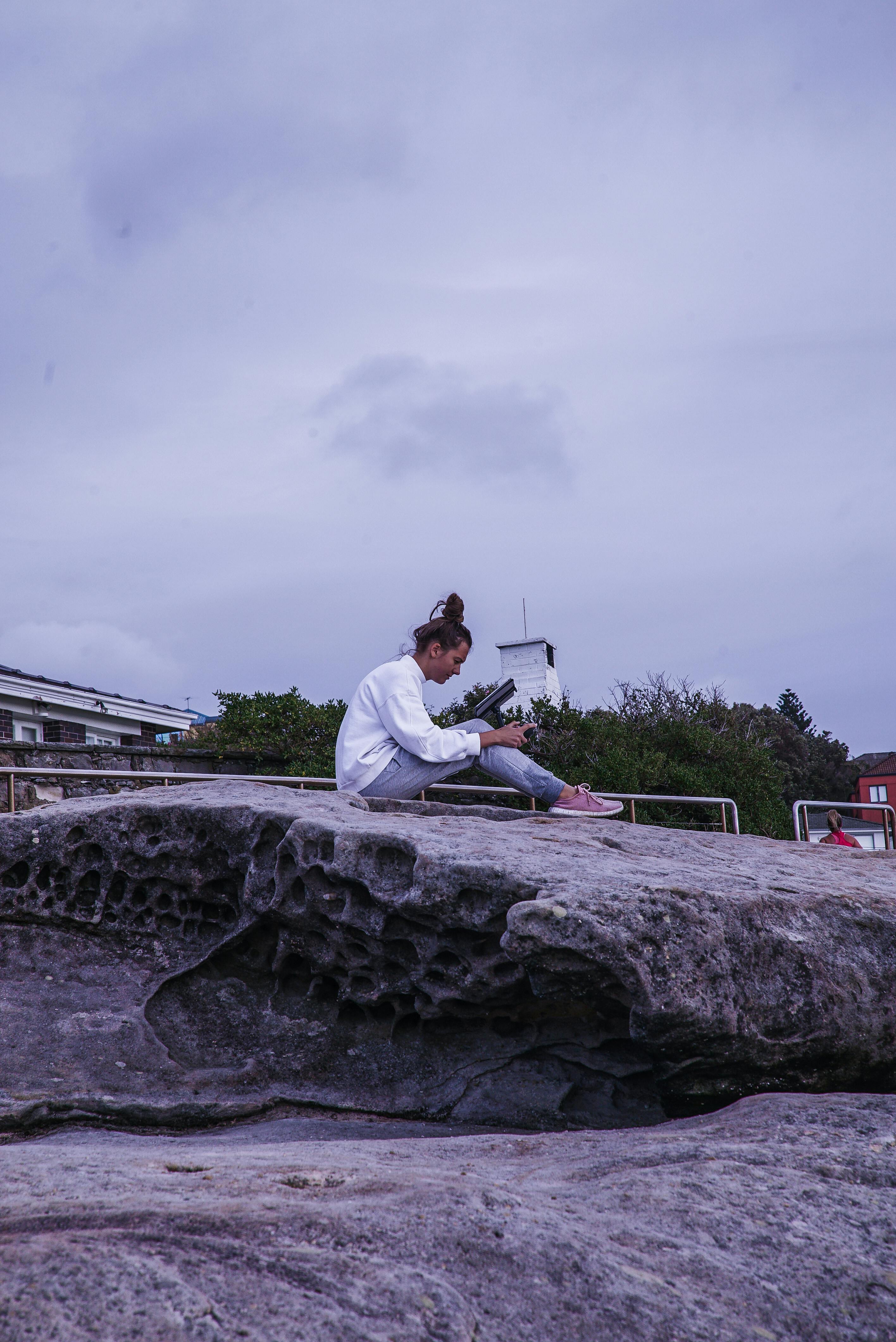 Lady Sitting On Rock Alone Photos, Download The BEST Free Lady Sitting ...