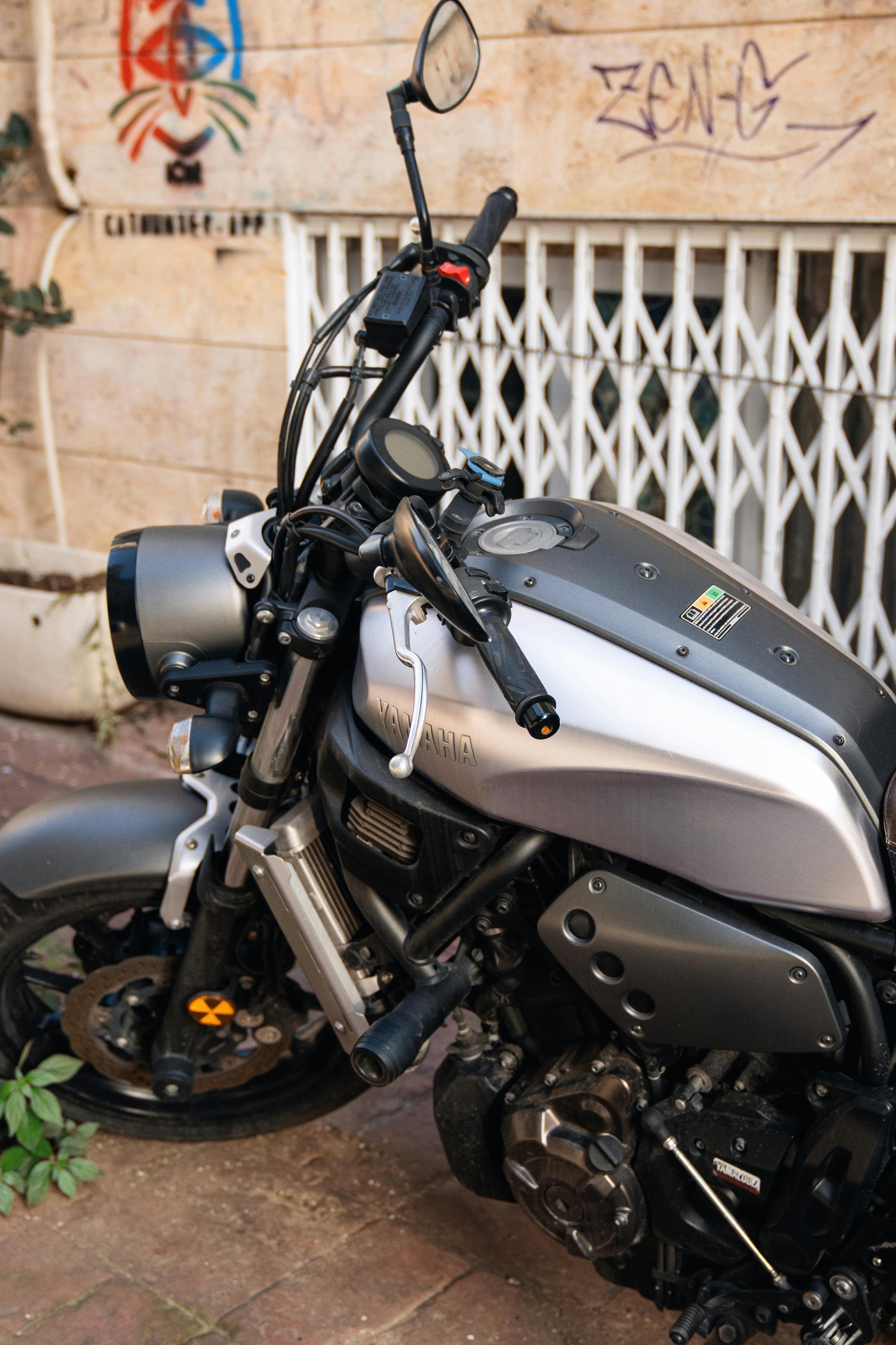 Closeup of a Motorcycle Parked by a Building · Free Stock Photo