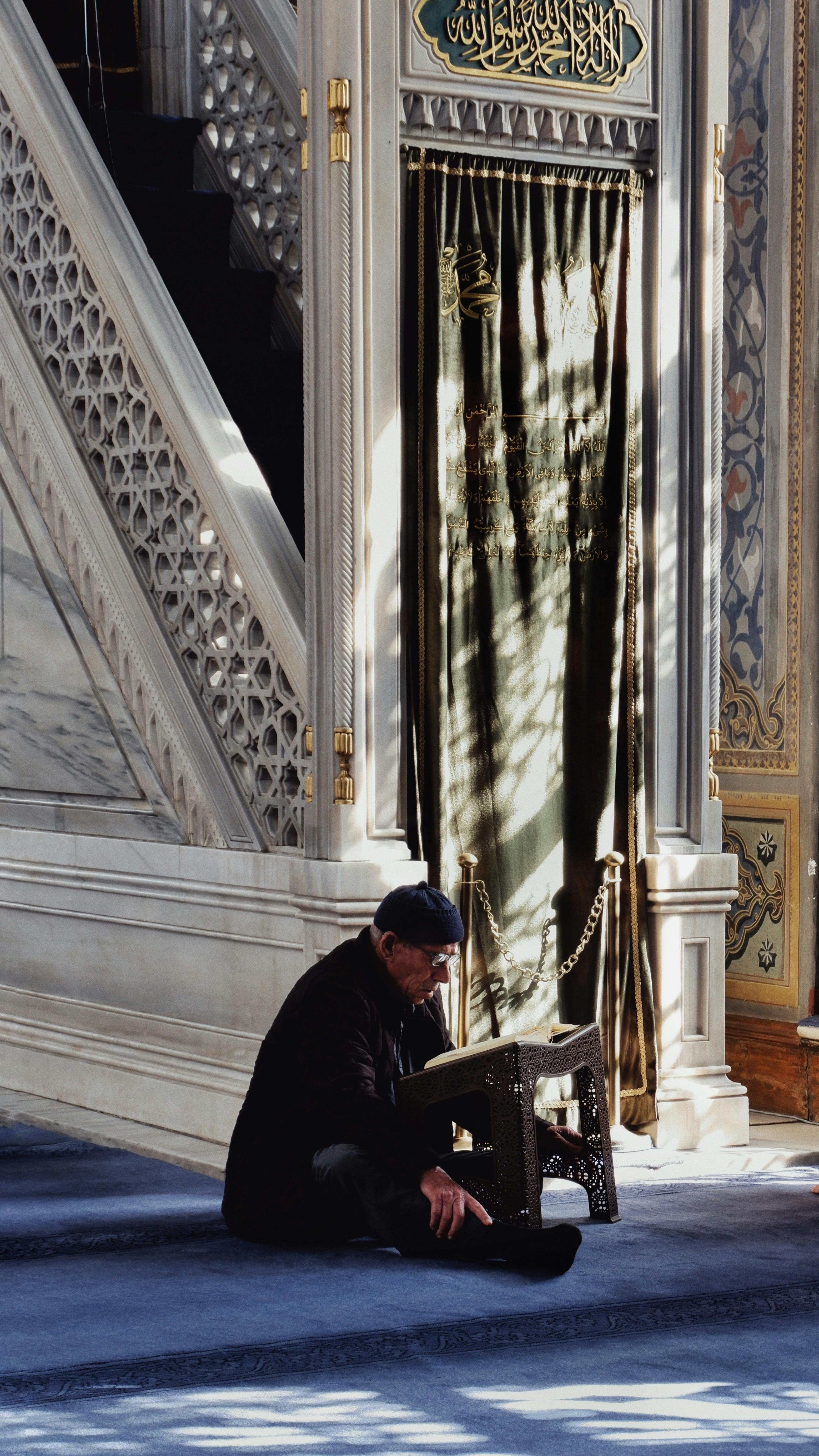 Worshipper Sitting in Darkness in Mosque · Free Stock Photo