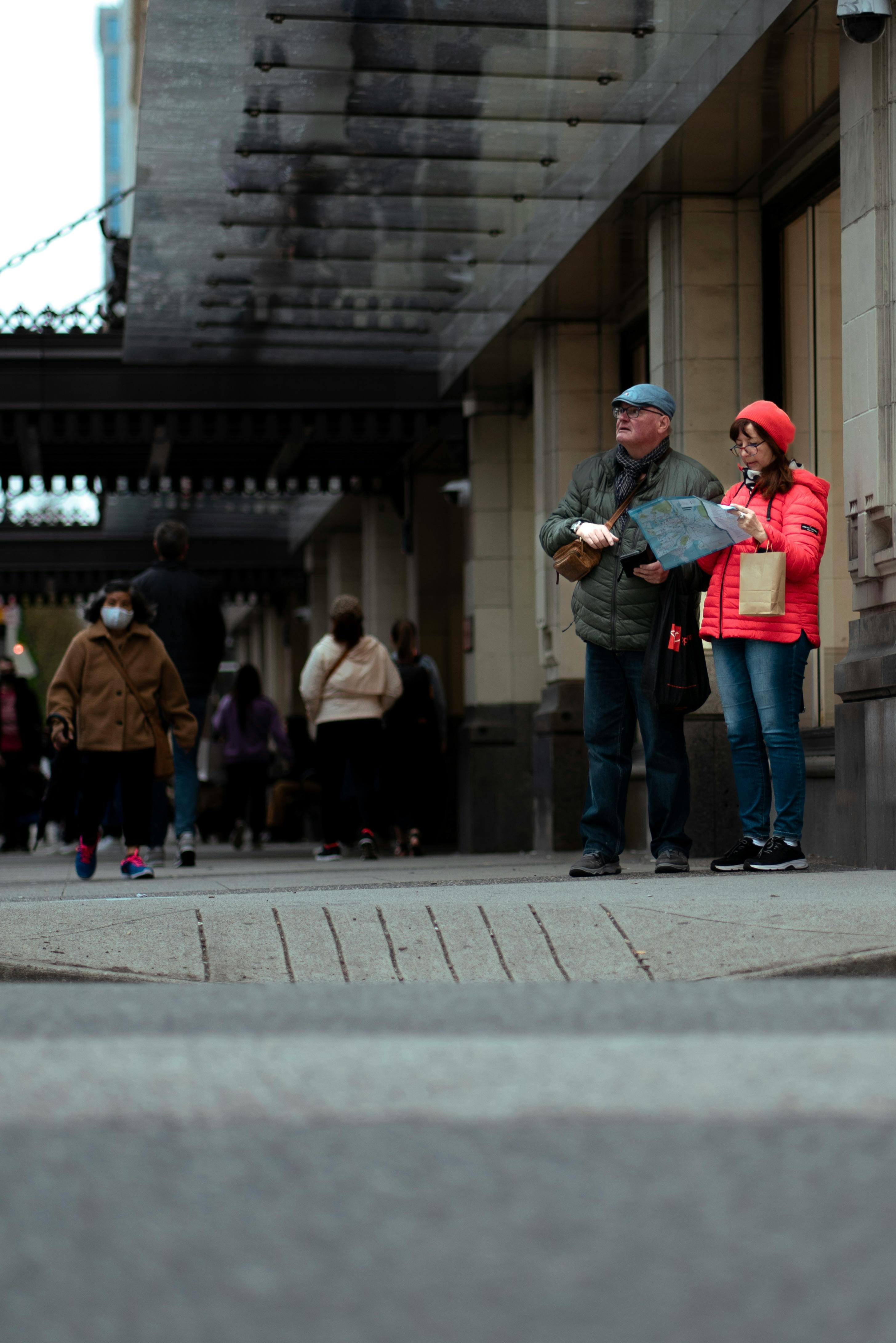People in Jackets on Sidewalk · Free Stock Photo