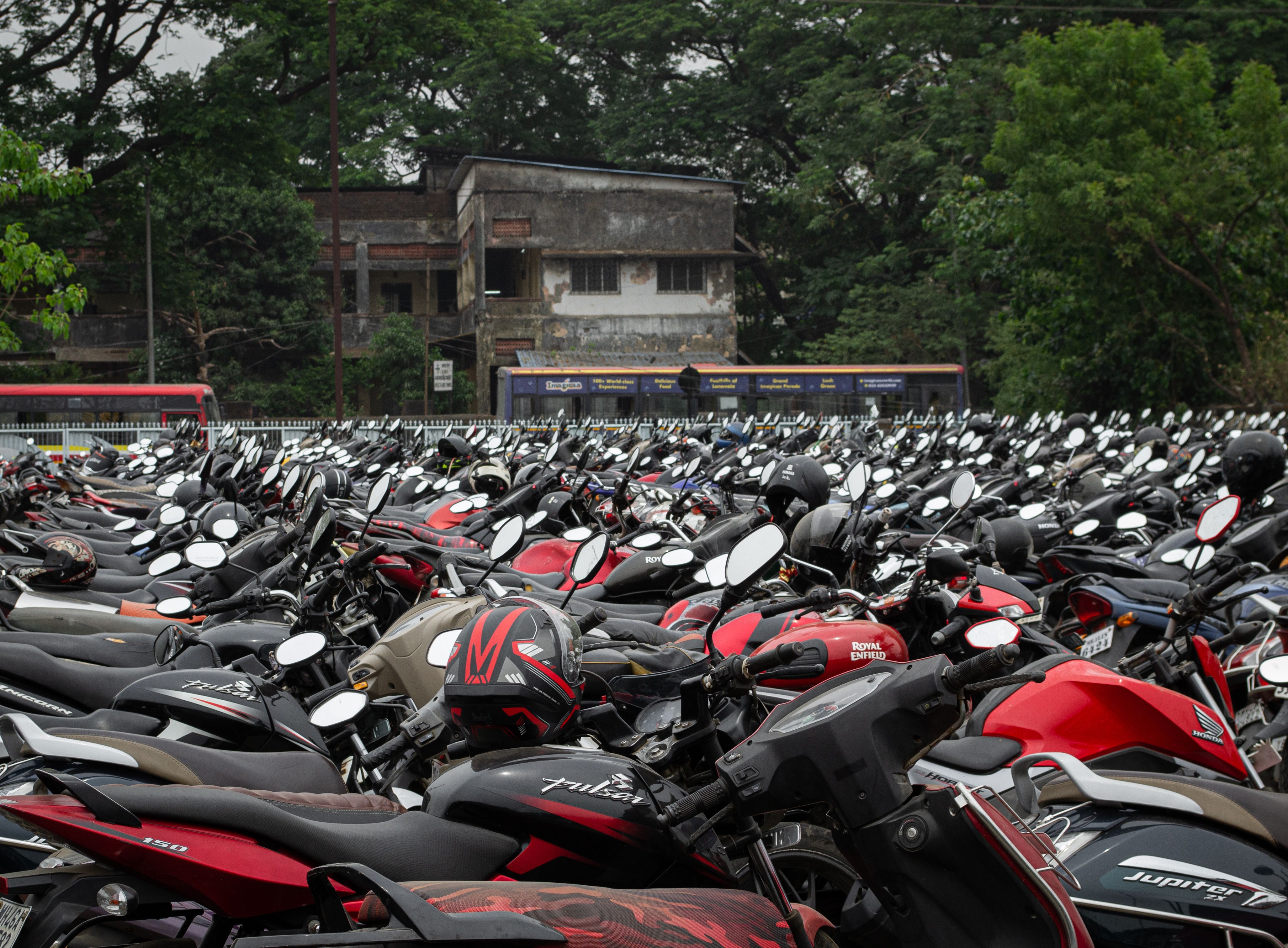A large group of motorcycles parked in a parking lot · Free Stock Photo