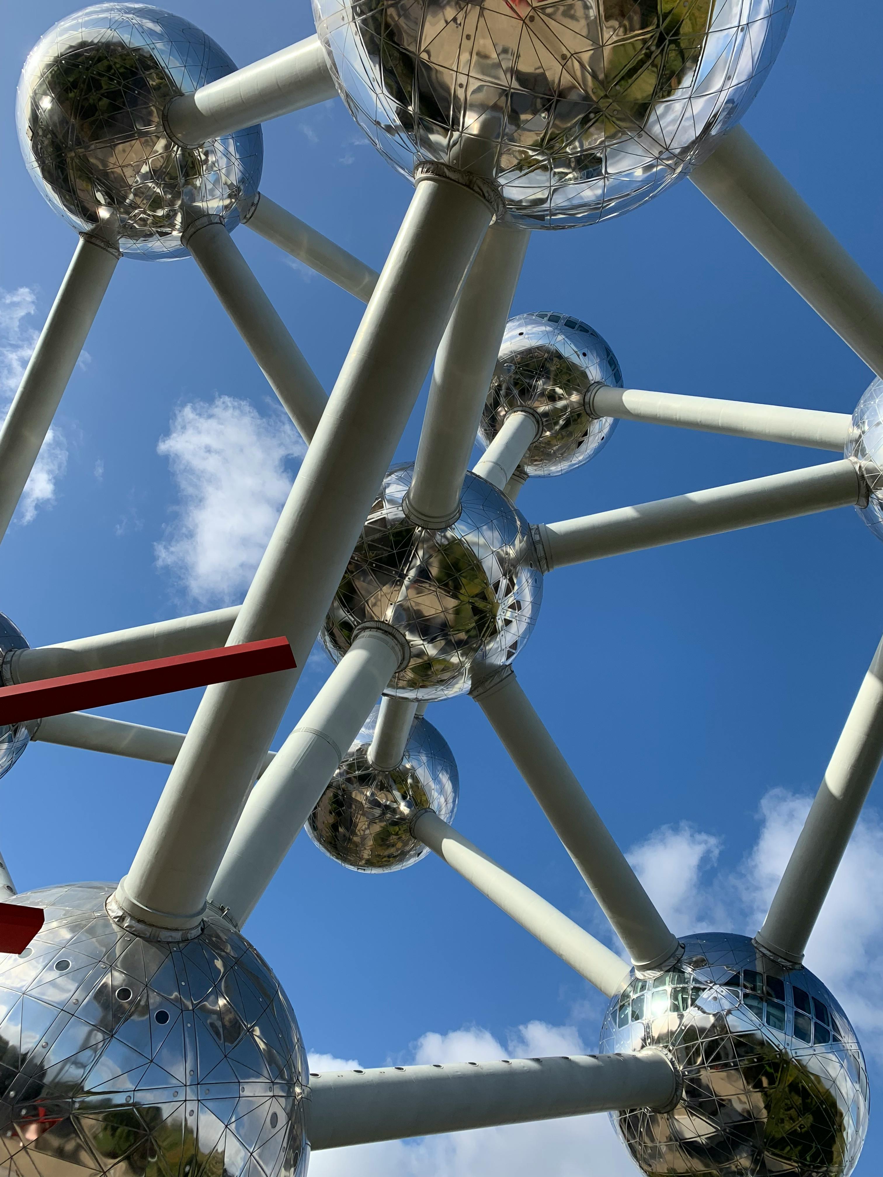 Low Angle Shot of Modern Sculpture Depicting an Atom · Free Stock Photo