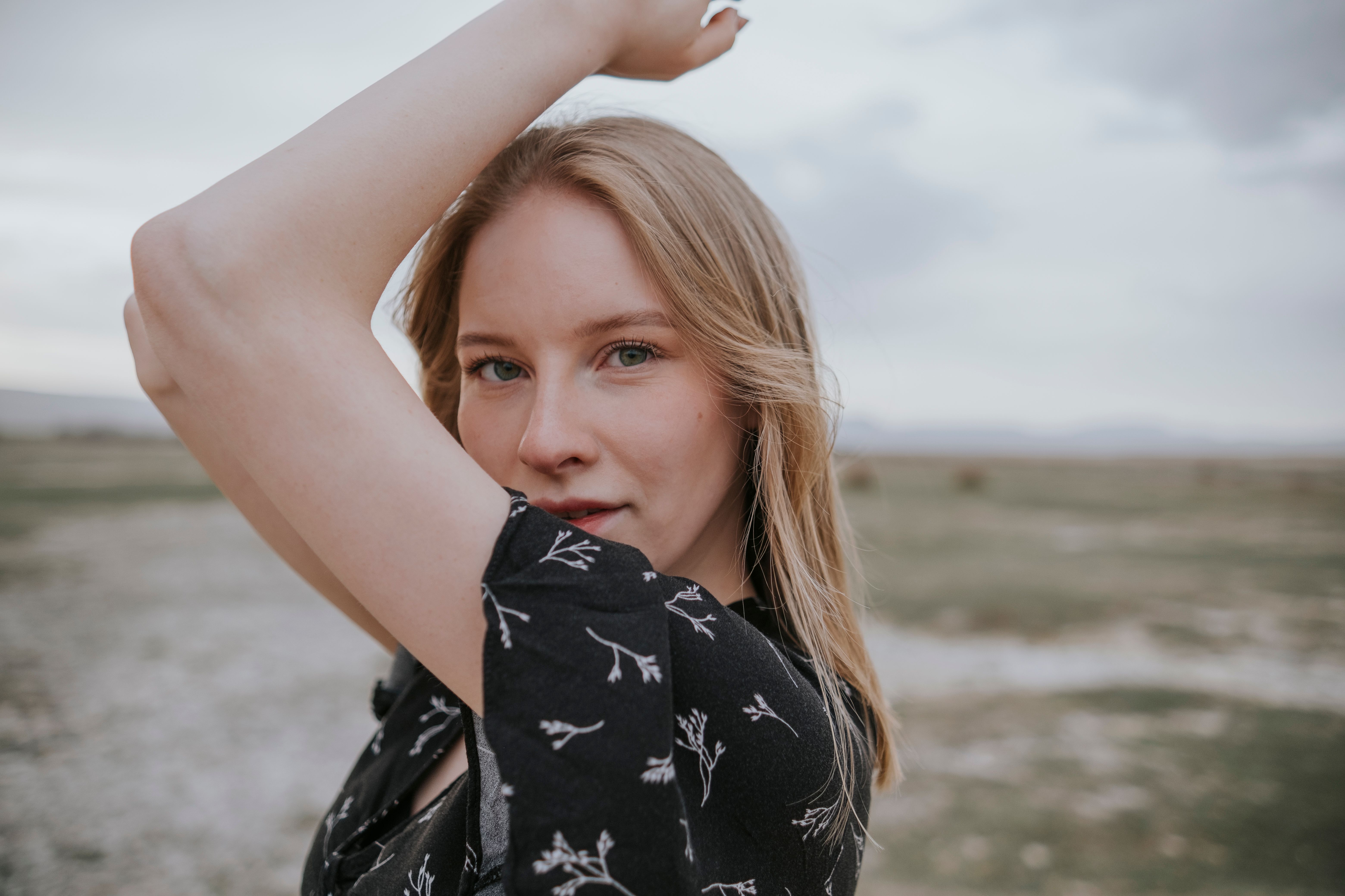 Blonde Woman Posing with Arms Raised · Free Stock Photo