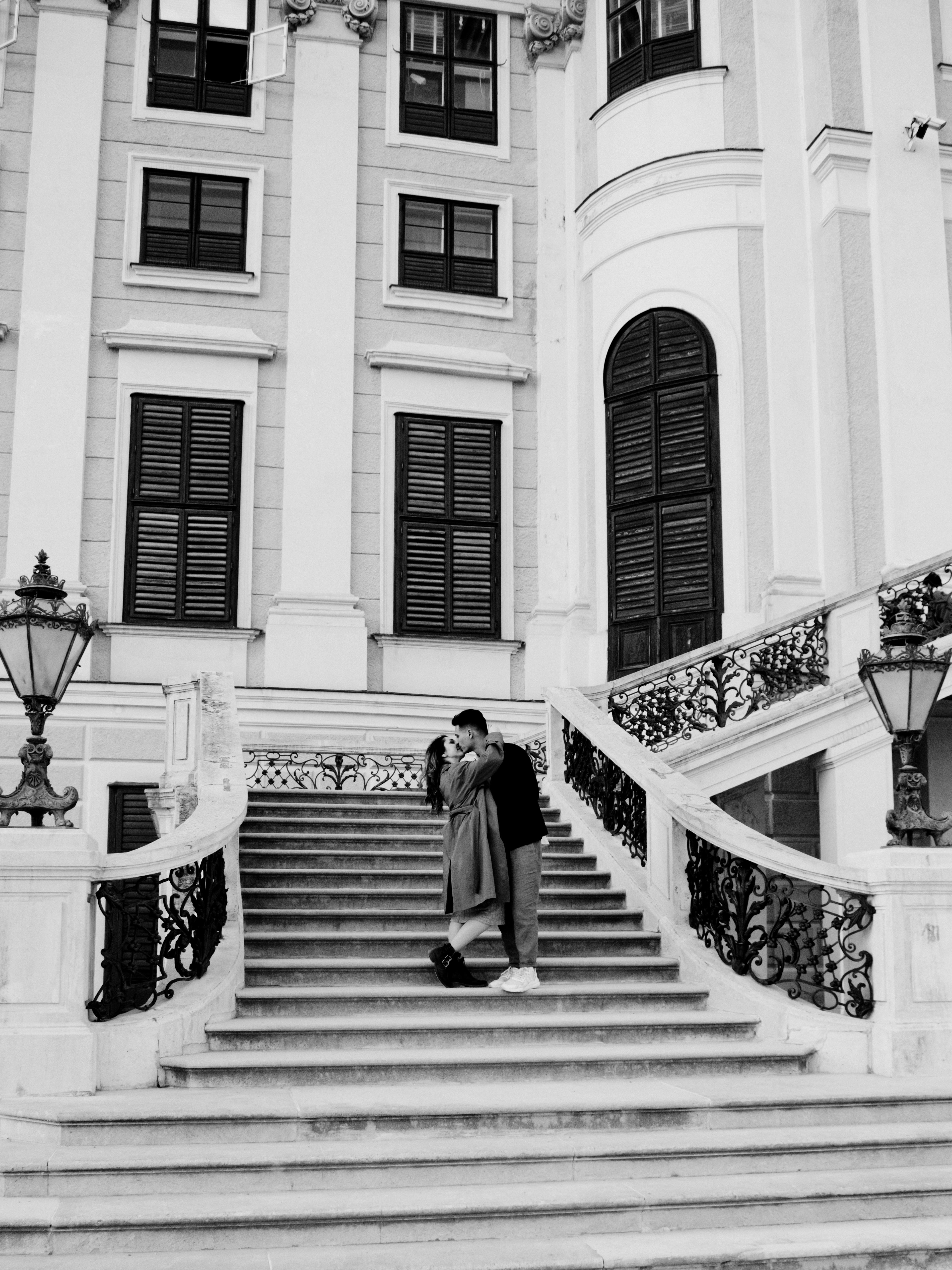 Couple Hugging by Building Wall · Free Stock Photo