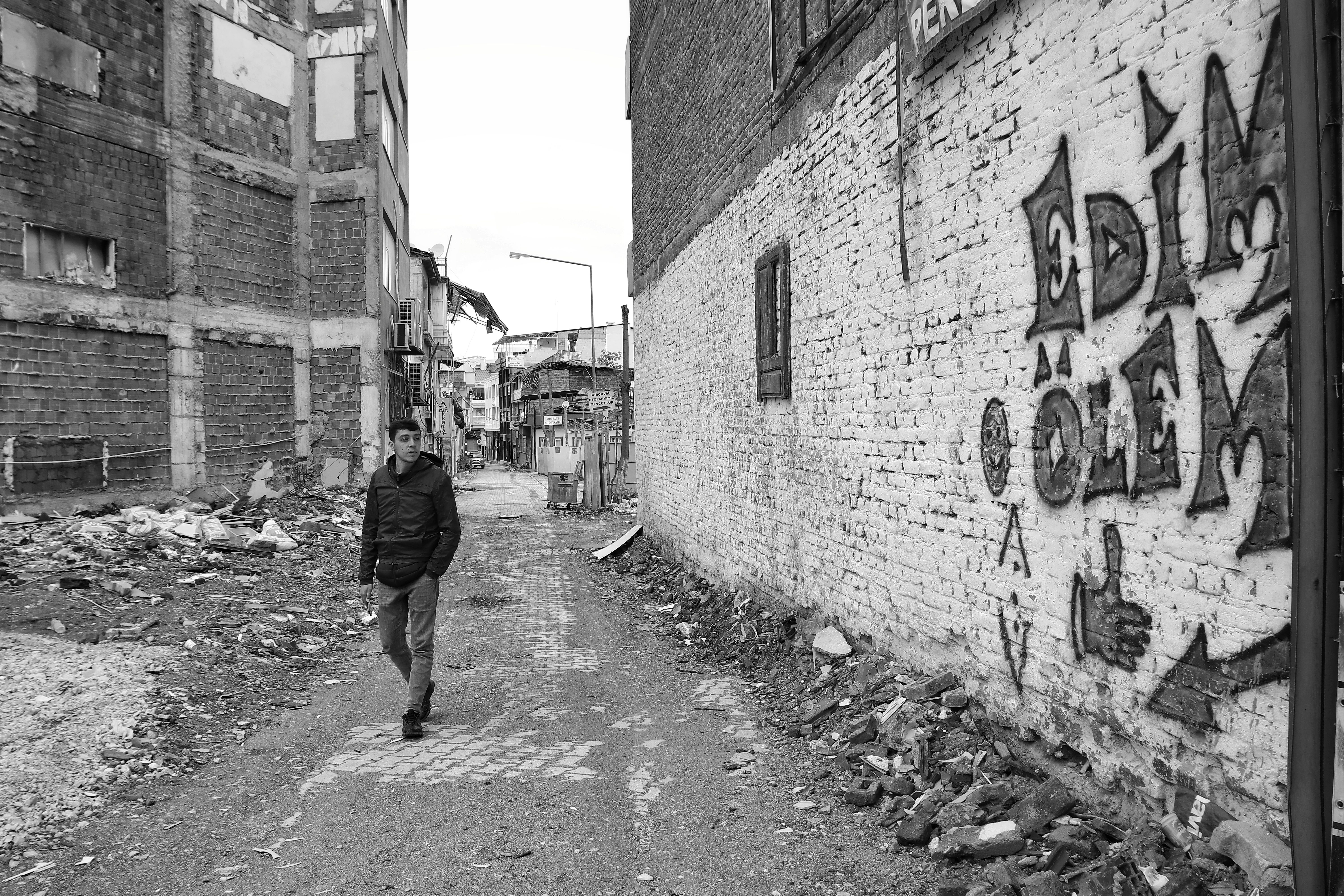 Young Man Walking among the Ruins of a City after an Earthquake · Free ...