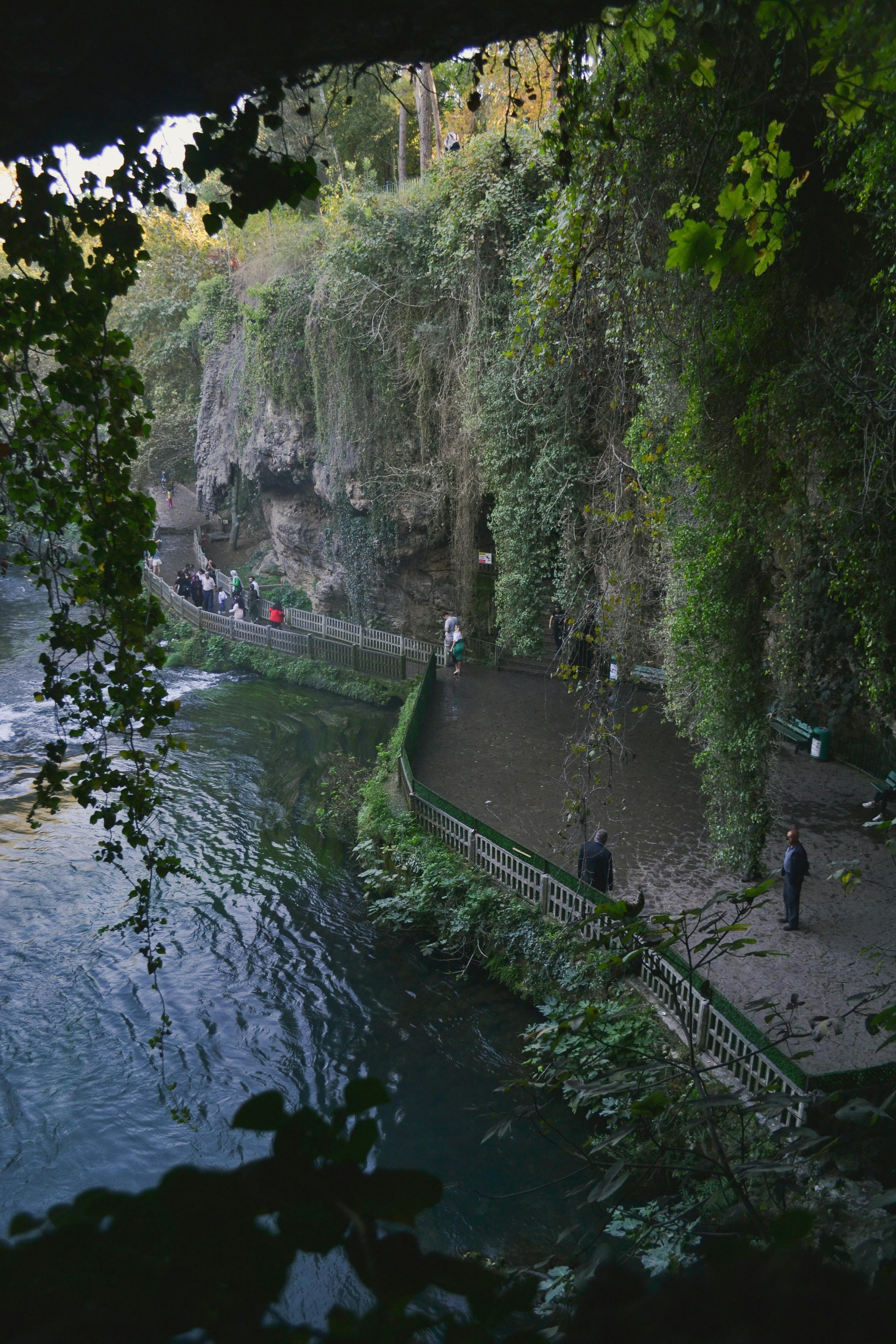 People under Rocks near River · Free Stock Photo