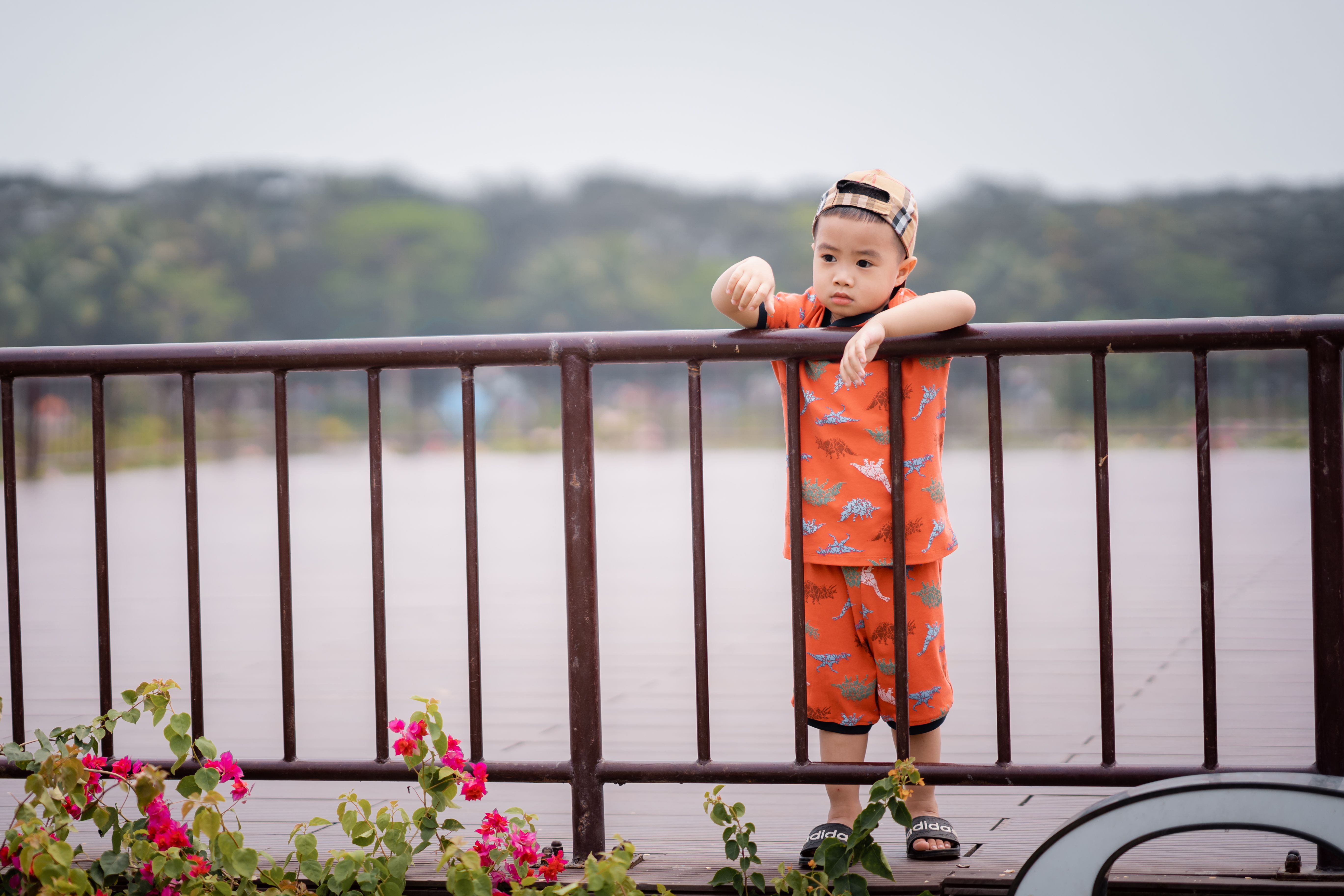Bored Little Boy Leaning Against the Railing · Free Stock Photo