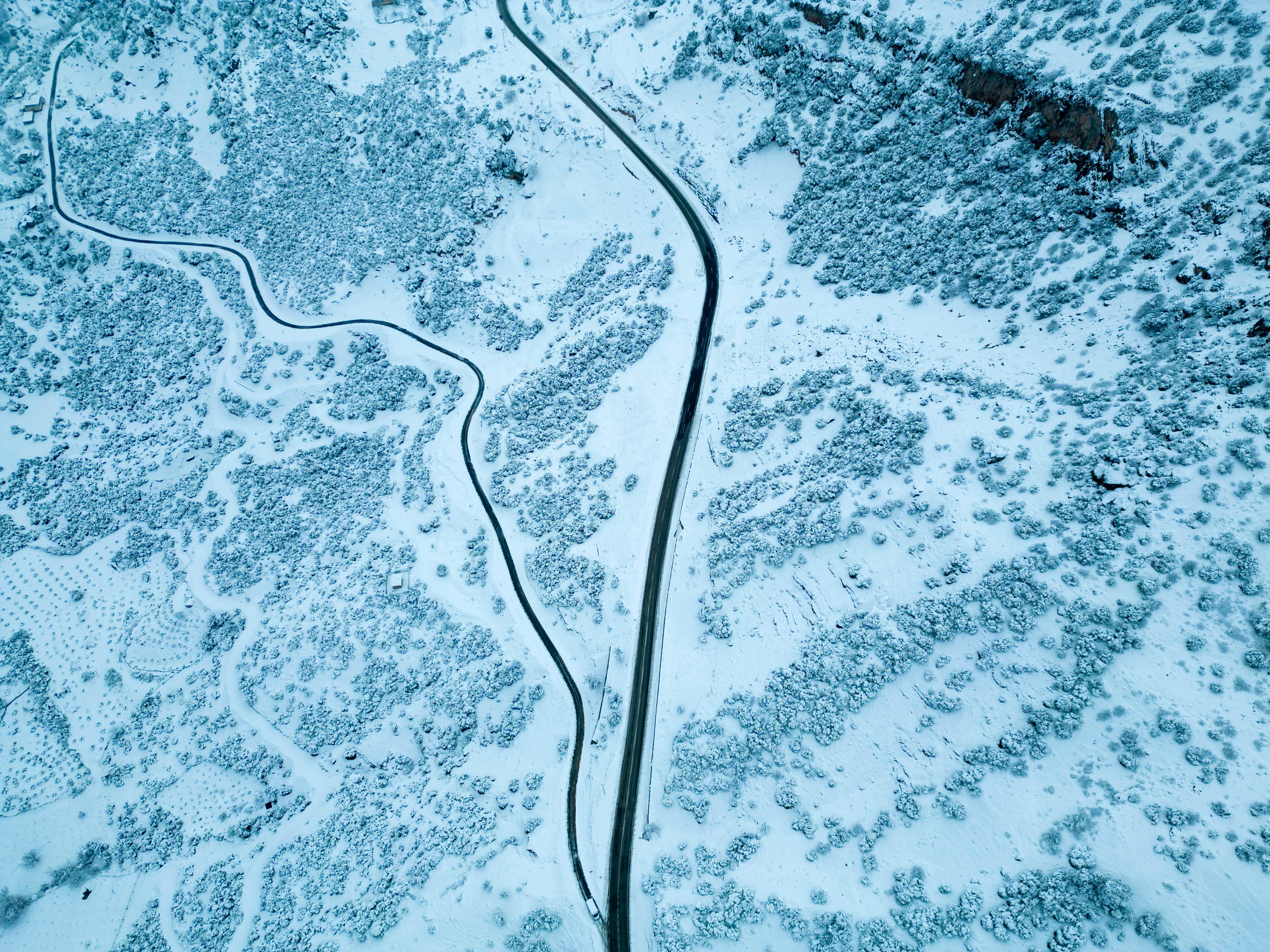 Aerial View of Roads on a Snow-covered Mountainside · Free Stock Photo