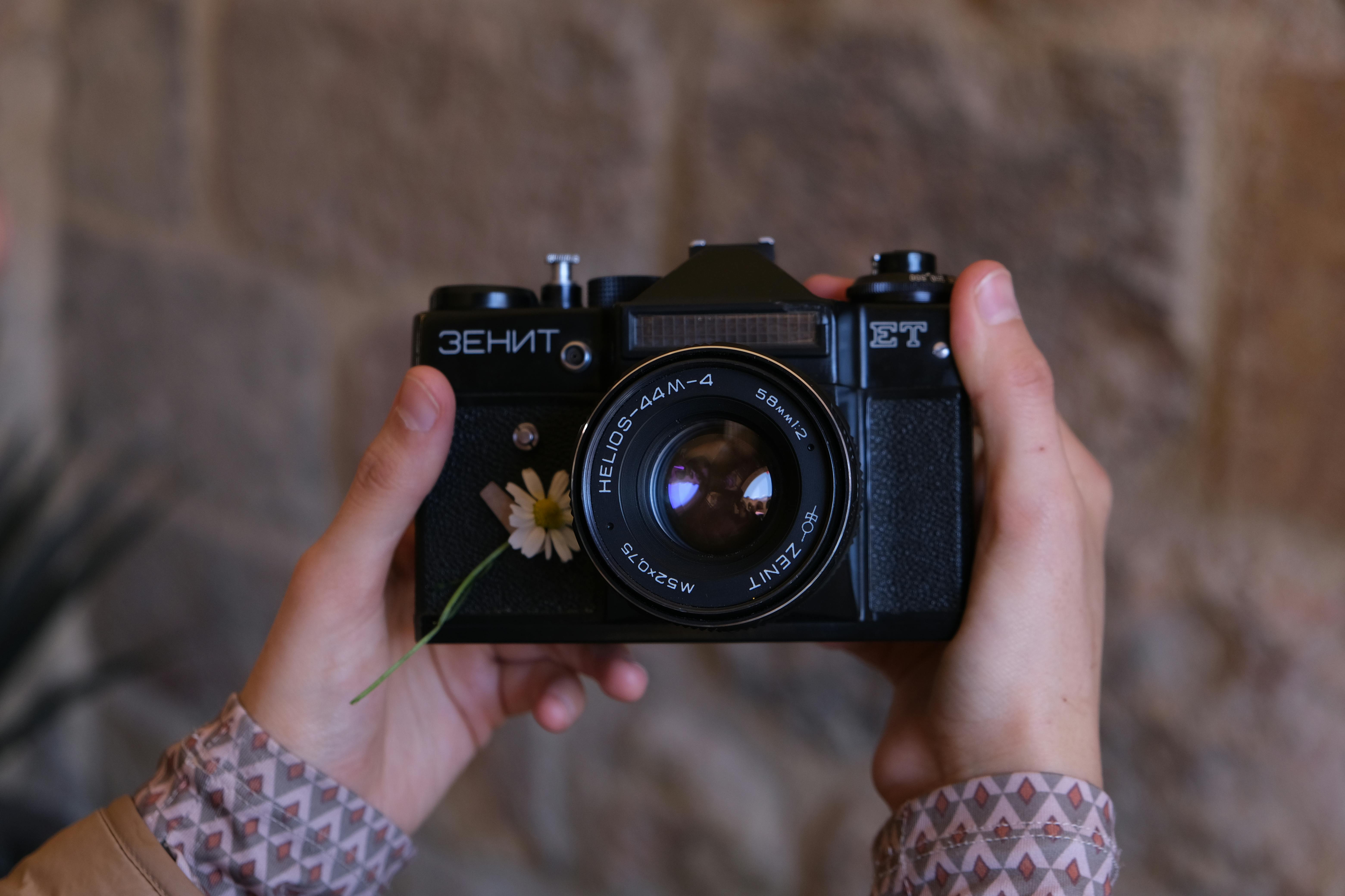Close-up of Woman Holding a Film Camera and a Flower · Free Stock Photo