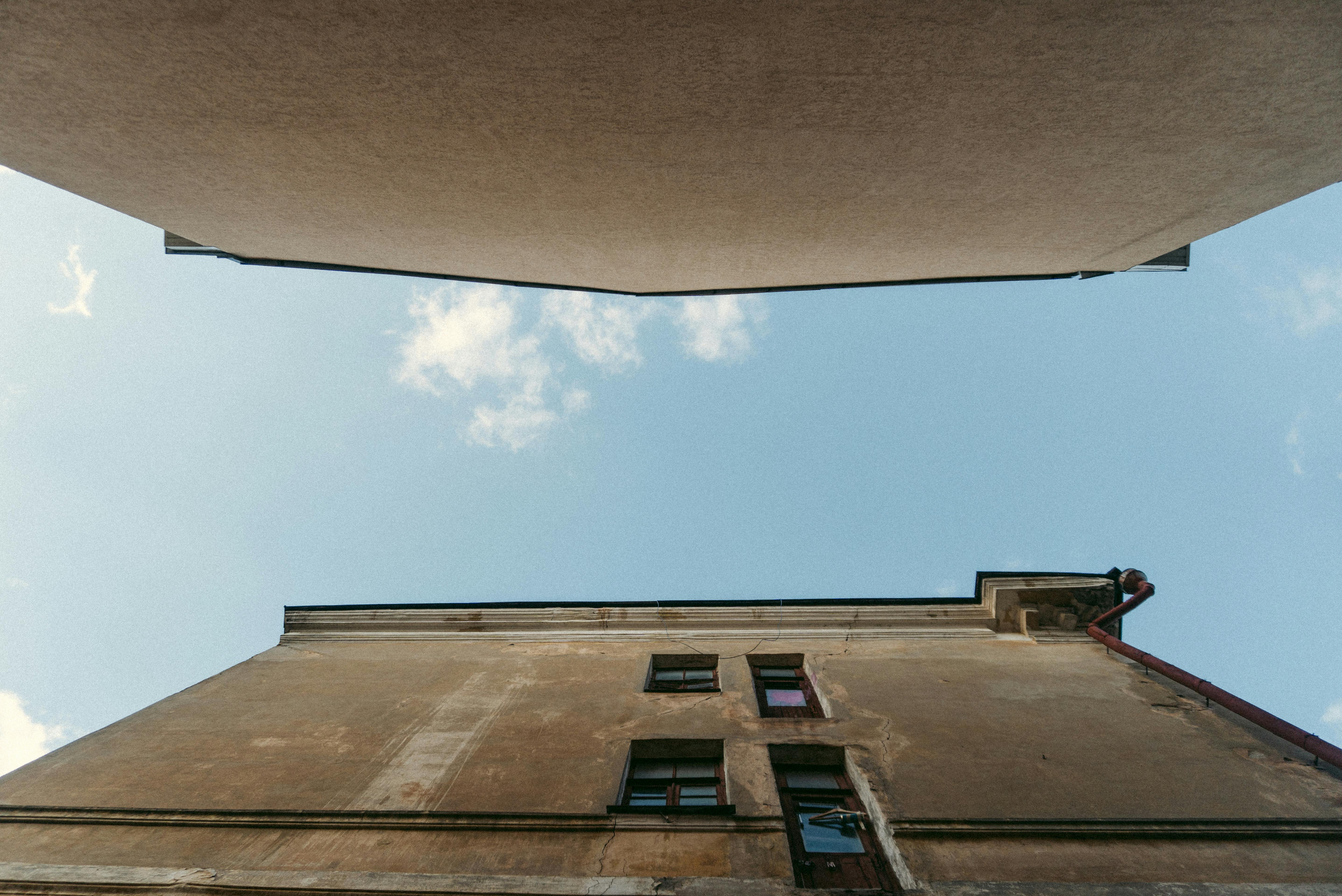 Clear Sky over Buildings Walls · Free Stock Photo