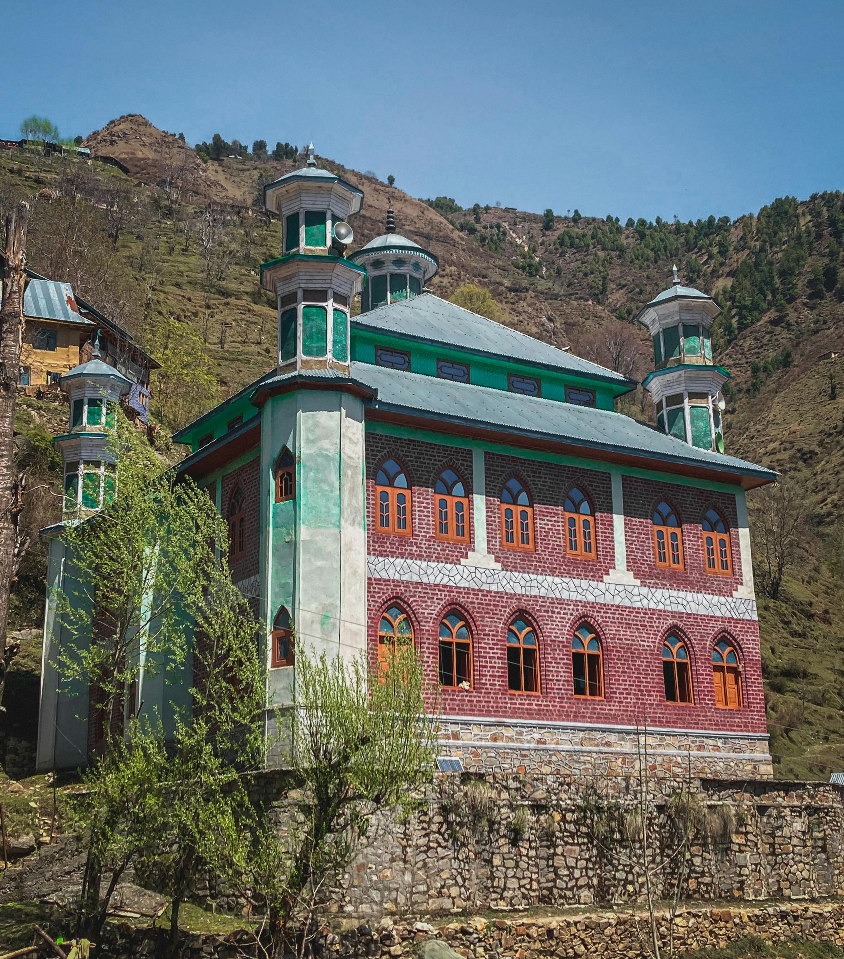 Ornamented Building under Hill · Free Stock Photo