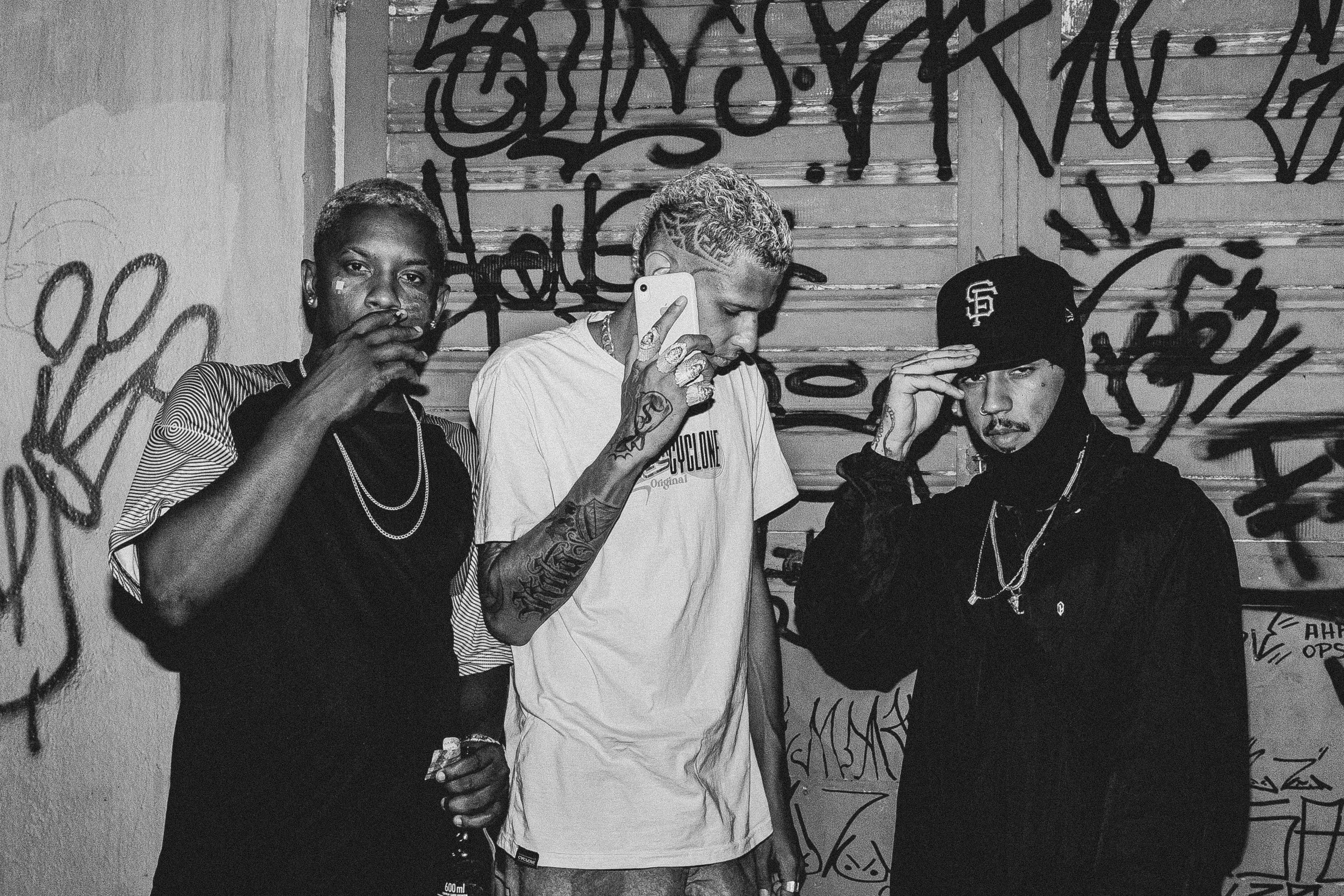 Hip Hop Men Posing Against Graffiti on Wall · Free Stock Photo