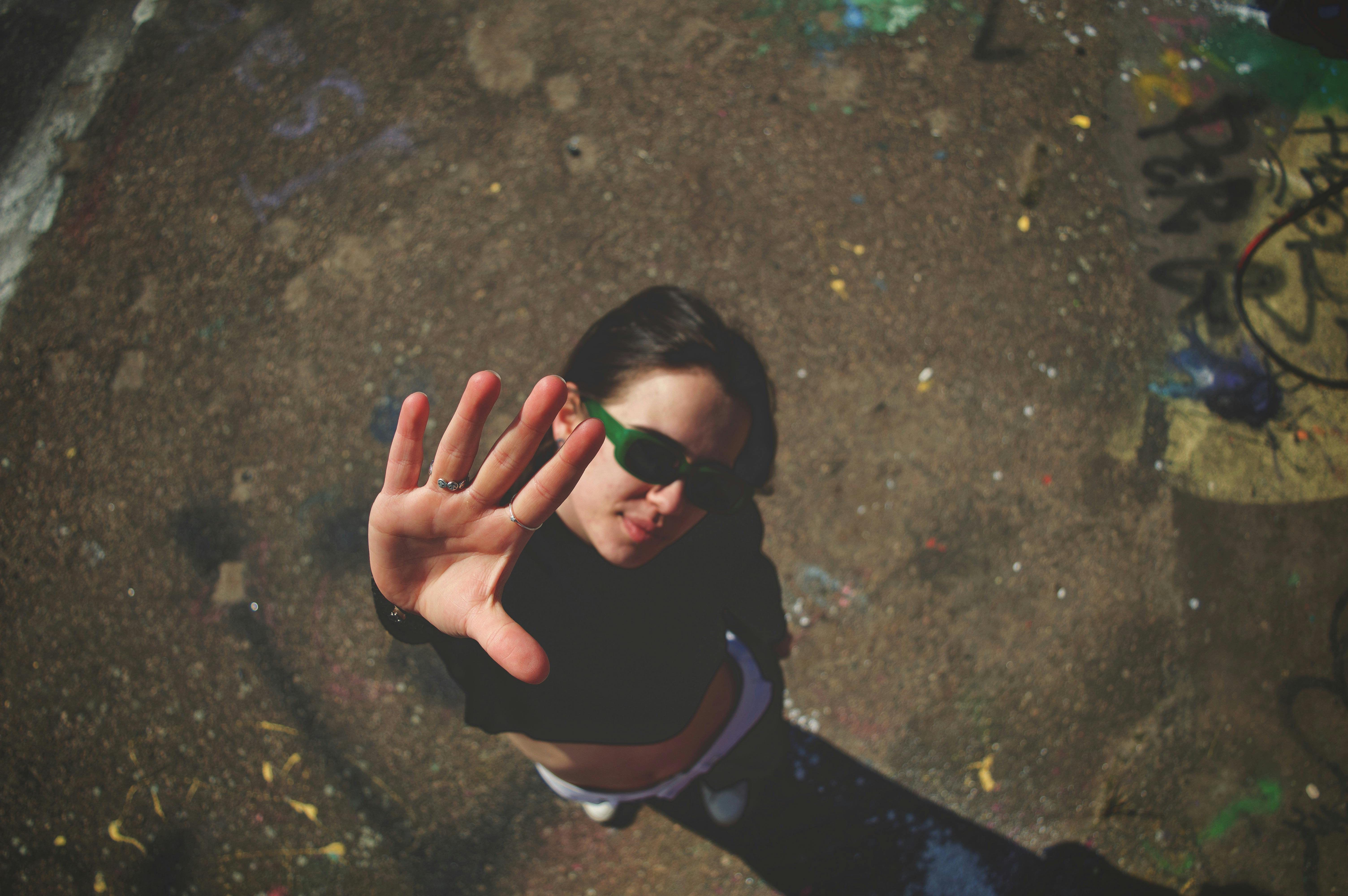 Woman Posing with Hand Raised · Free Stock Photo