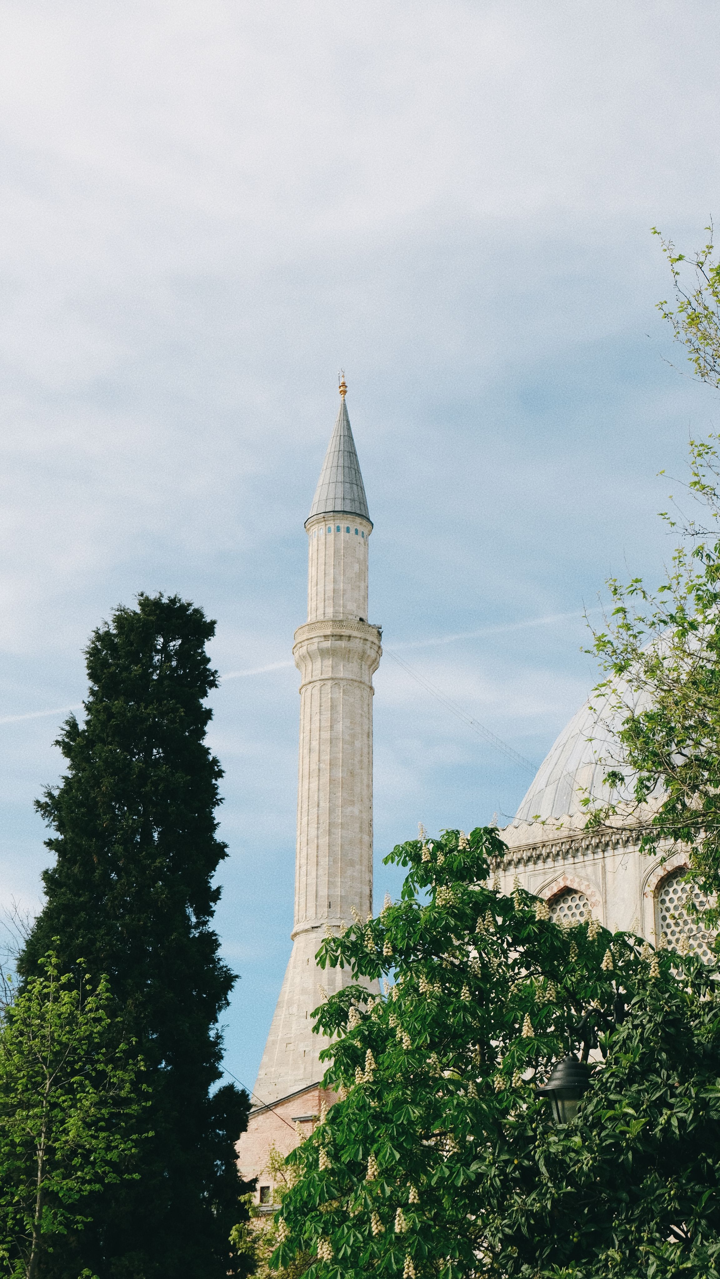 Top of the Minaret Tower Against a Blue Sky Background · Free Stock Photo