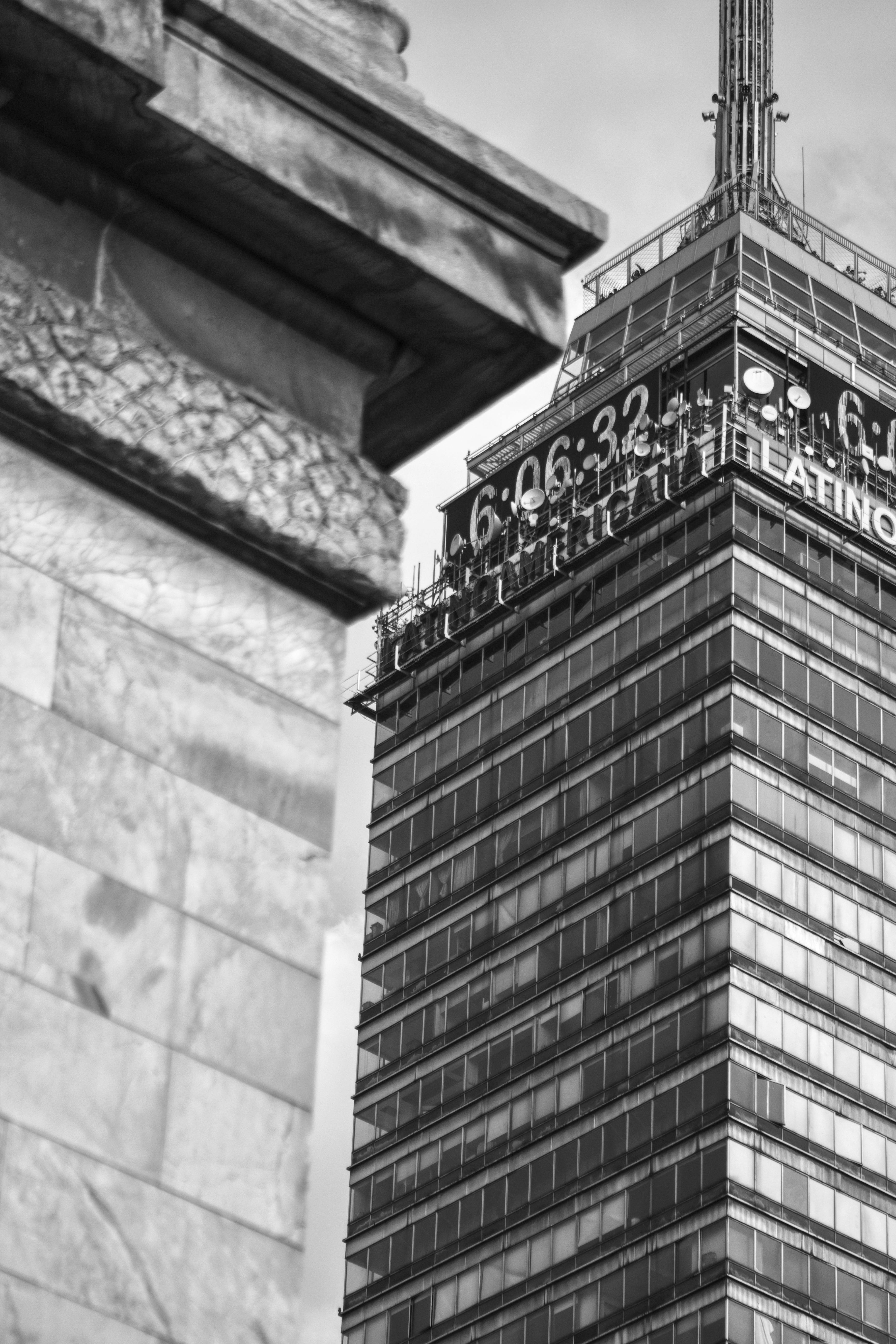 Black and White Photo of a Wall and a Tower Building · Free Stock Photo