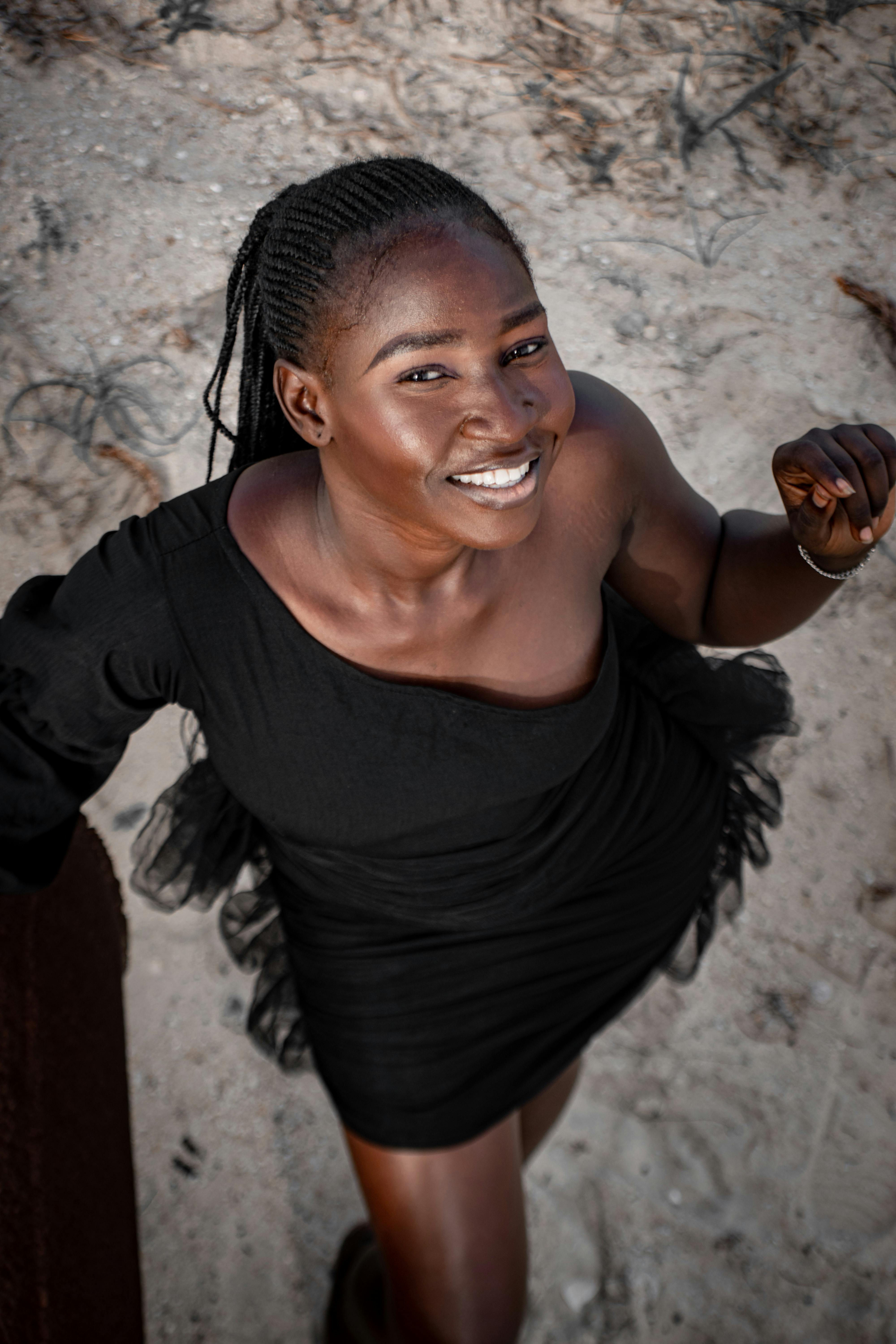 Smiling Woman Lying in Thigh-High Slit Dress · Free Stock Photo