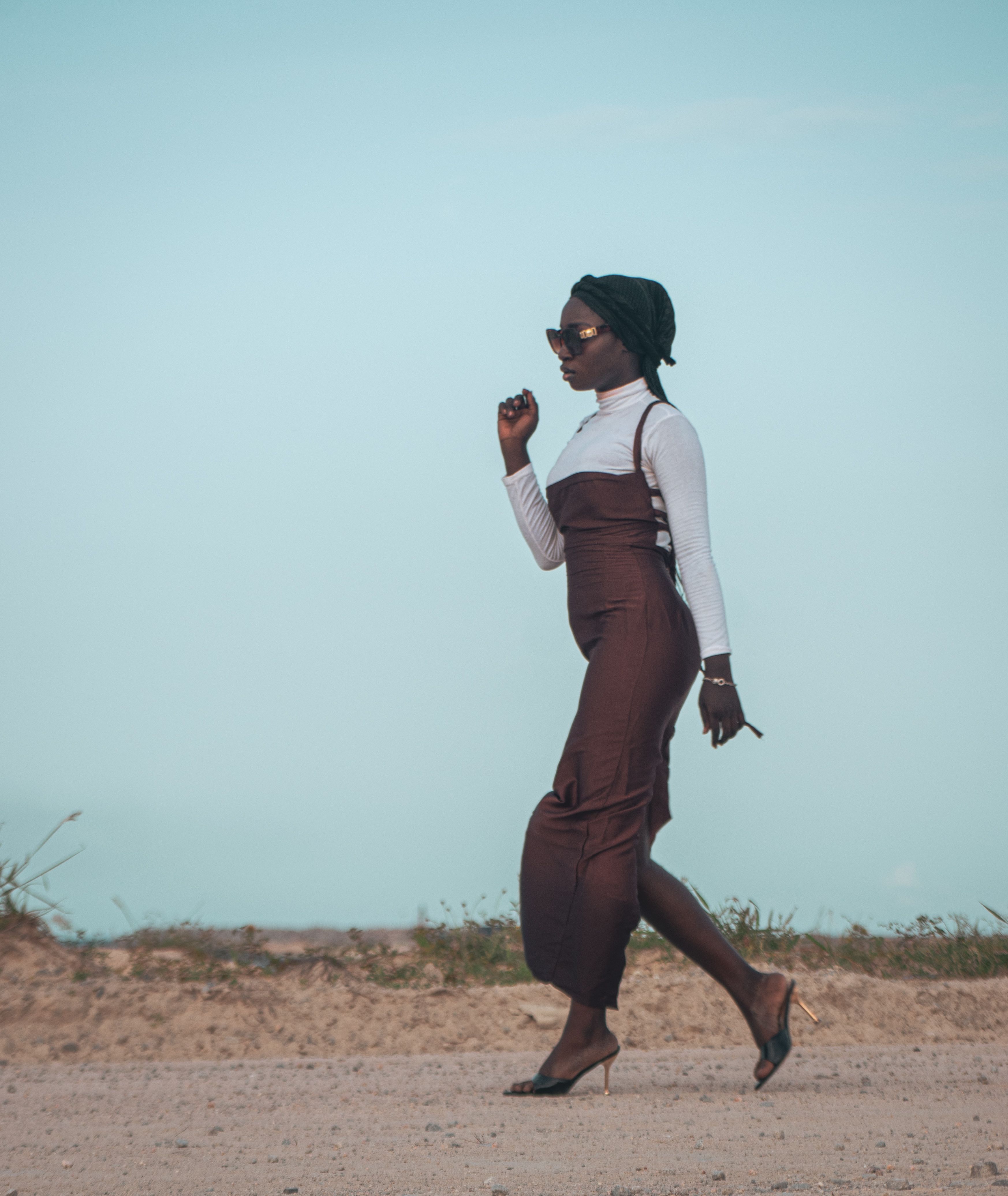 Woman Wearing a Long Brown Dress Walking on Sand in High Heels · Free ...