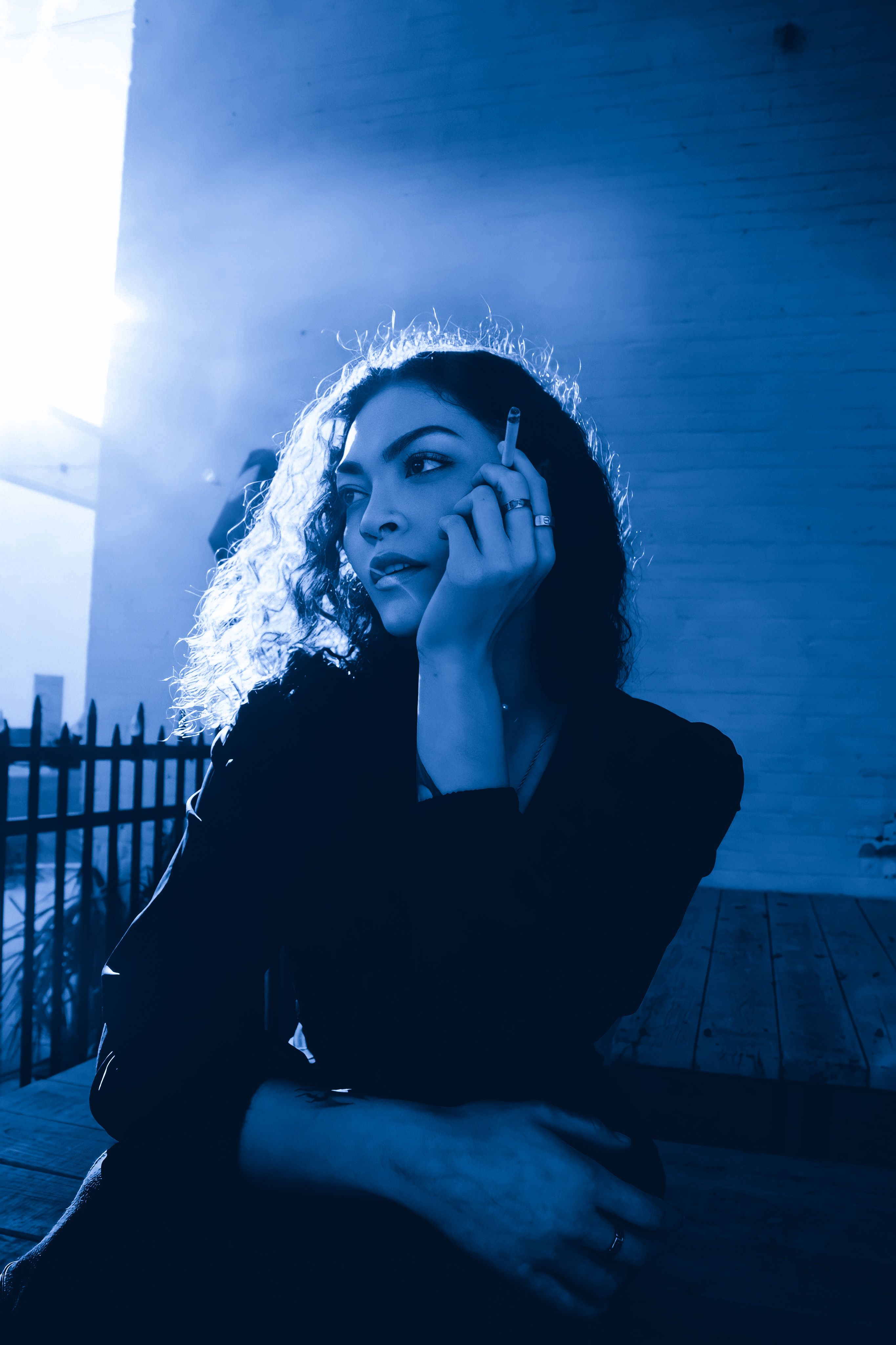 Woman Sitting and Smoking Cigarette · Free Stock Photo