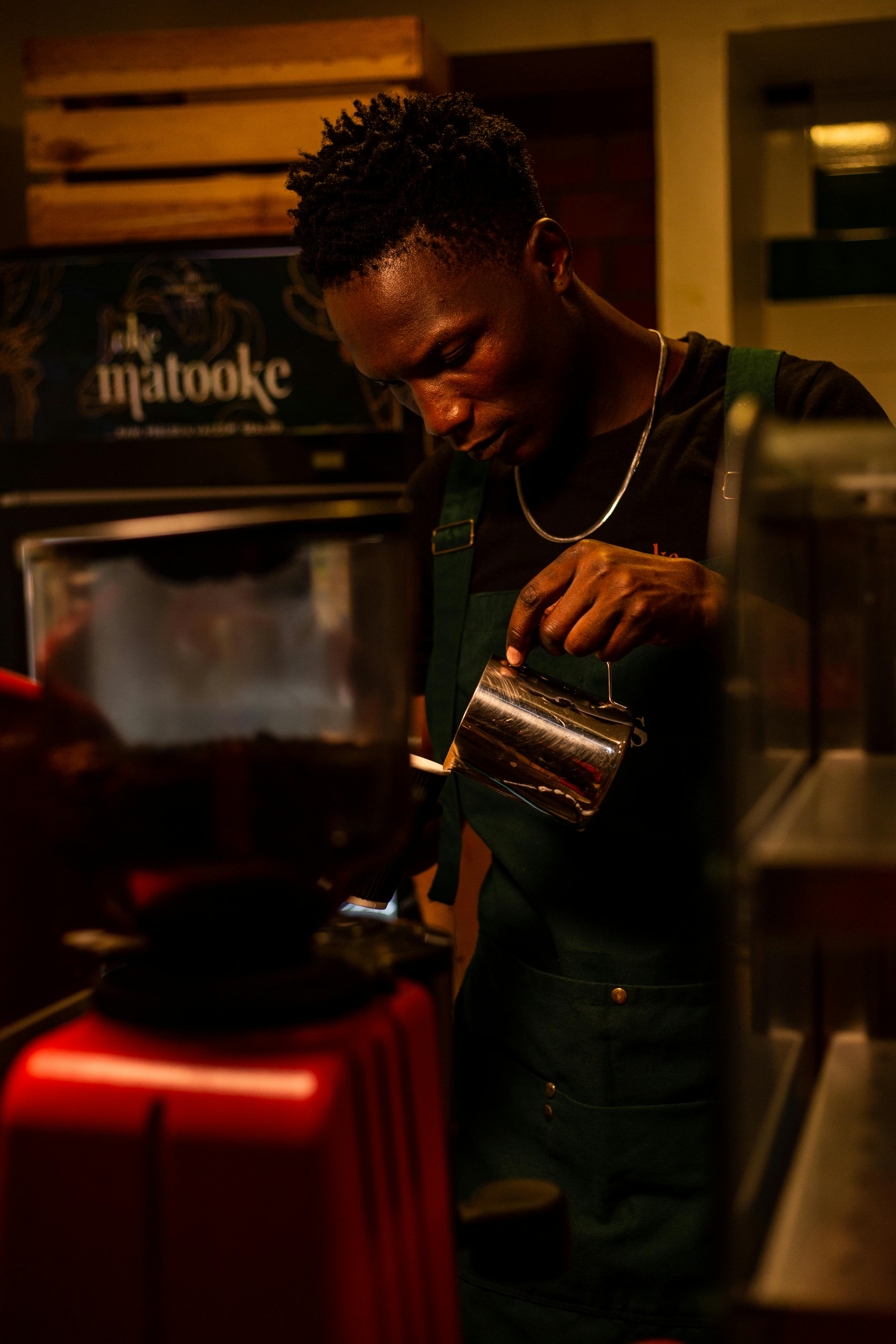 A Man Standing In Front of the Bar Counter · Free Stock Photo
