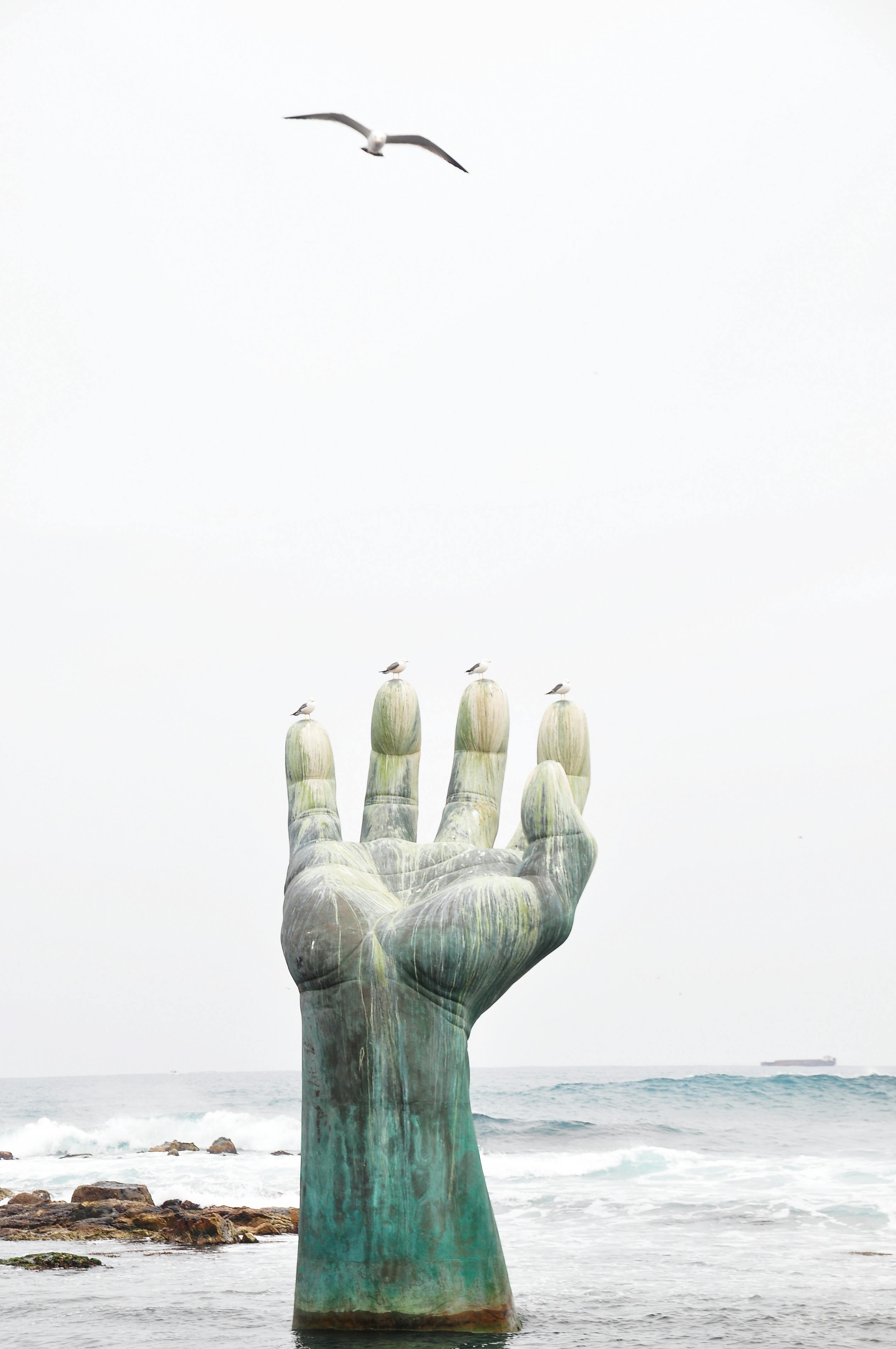 Statue of a Human Hand in the Sea · Free Stock Photo