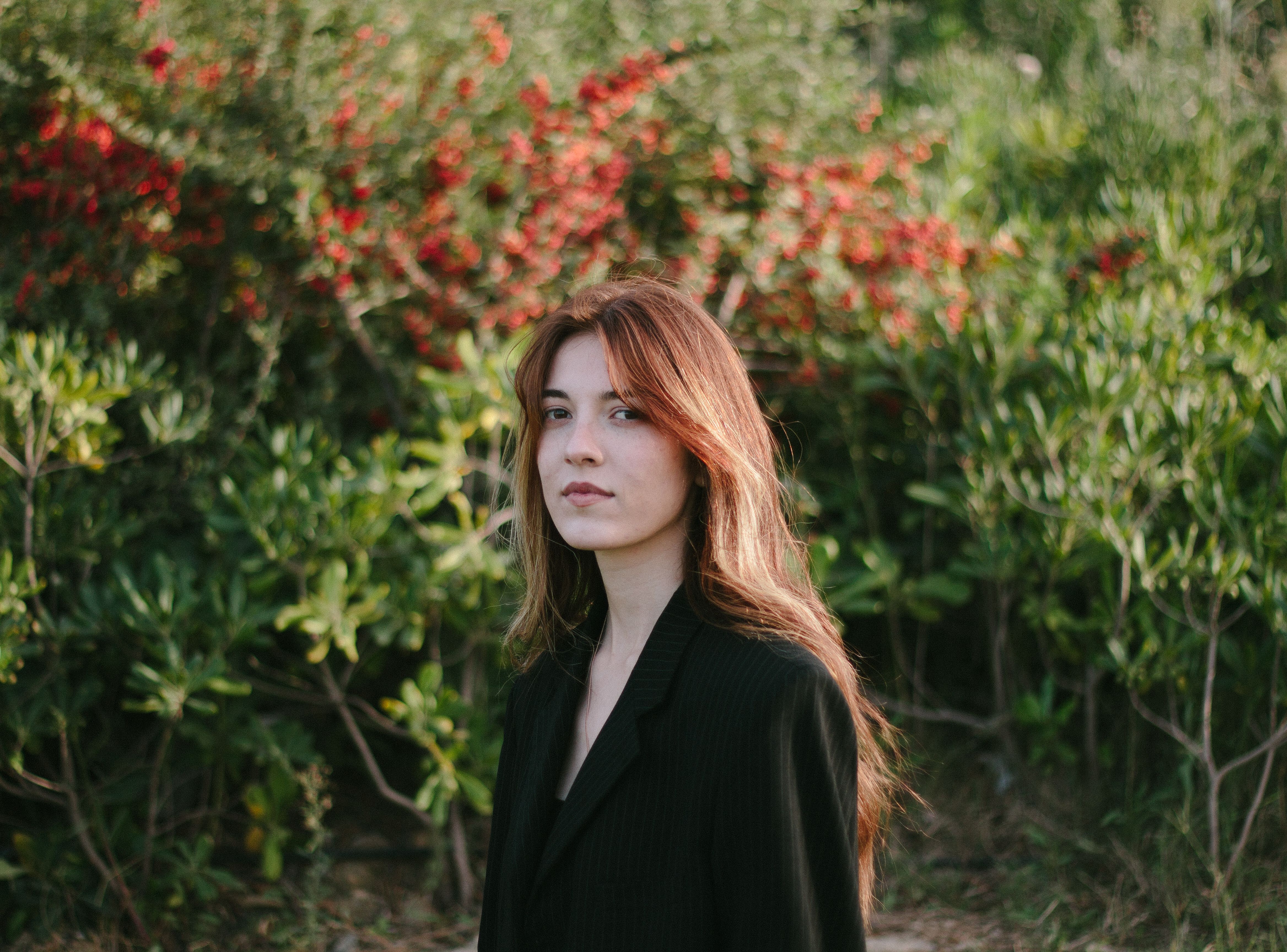 Woman Portrait with Bushes behind · Free Stock Photo