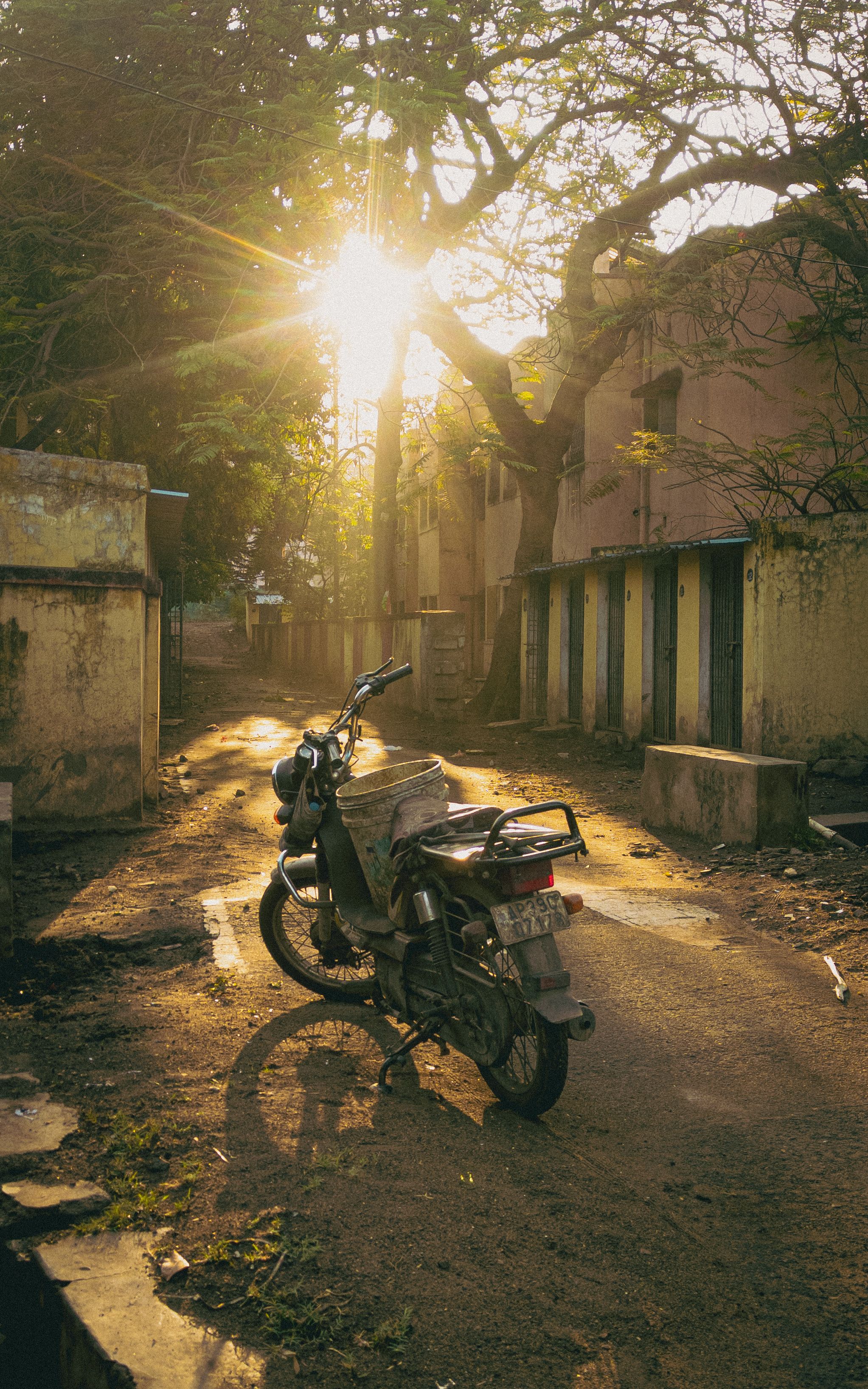 Sunlight Shining on Motorcycle Parked in Courtyard between Abandoned ...